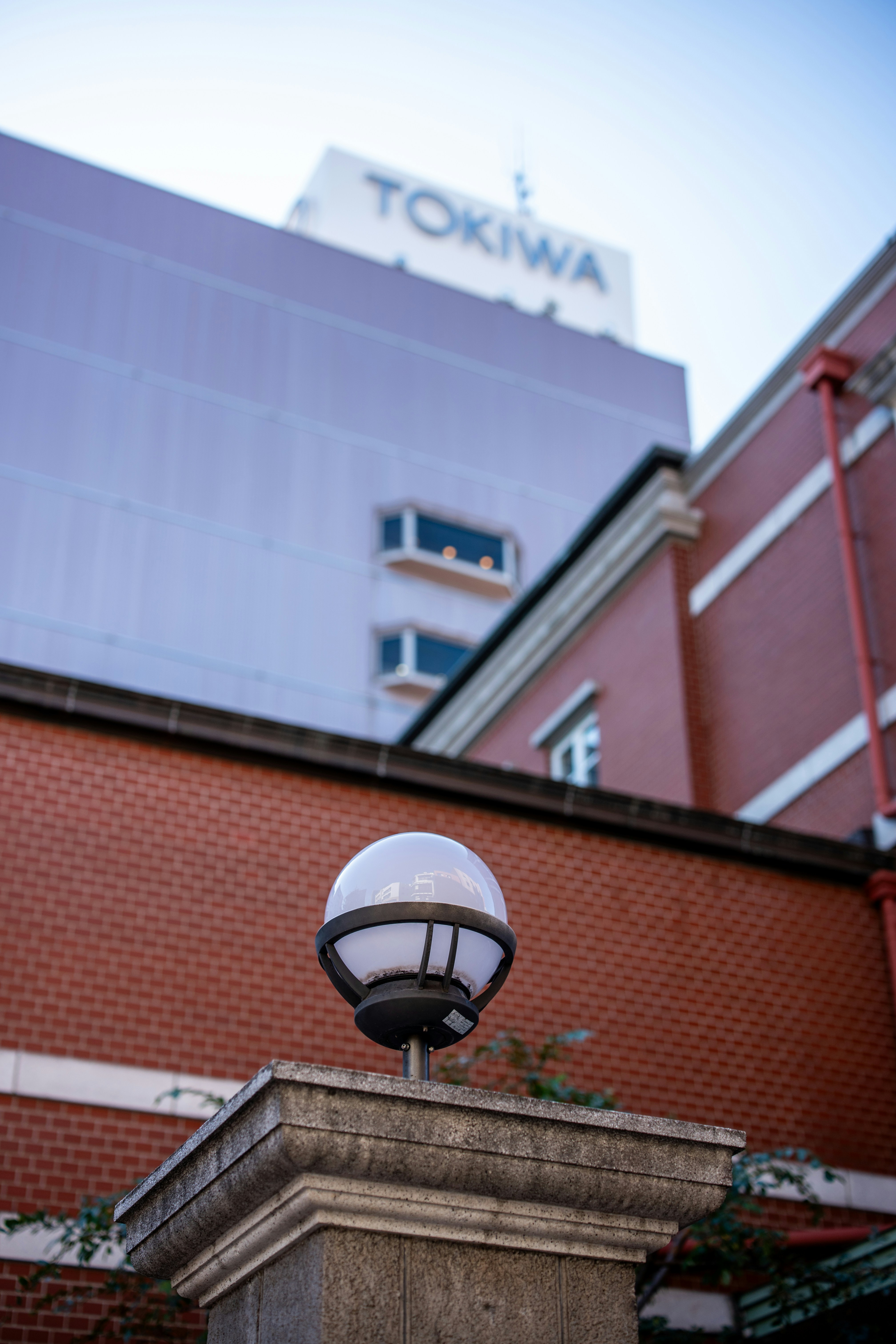 Globe Light over Brick Terrace: Urban Focus on a Quiet Courtyard