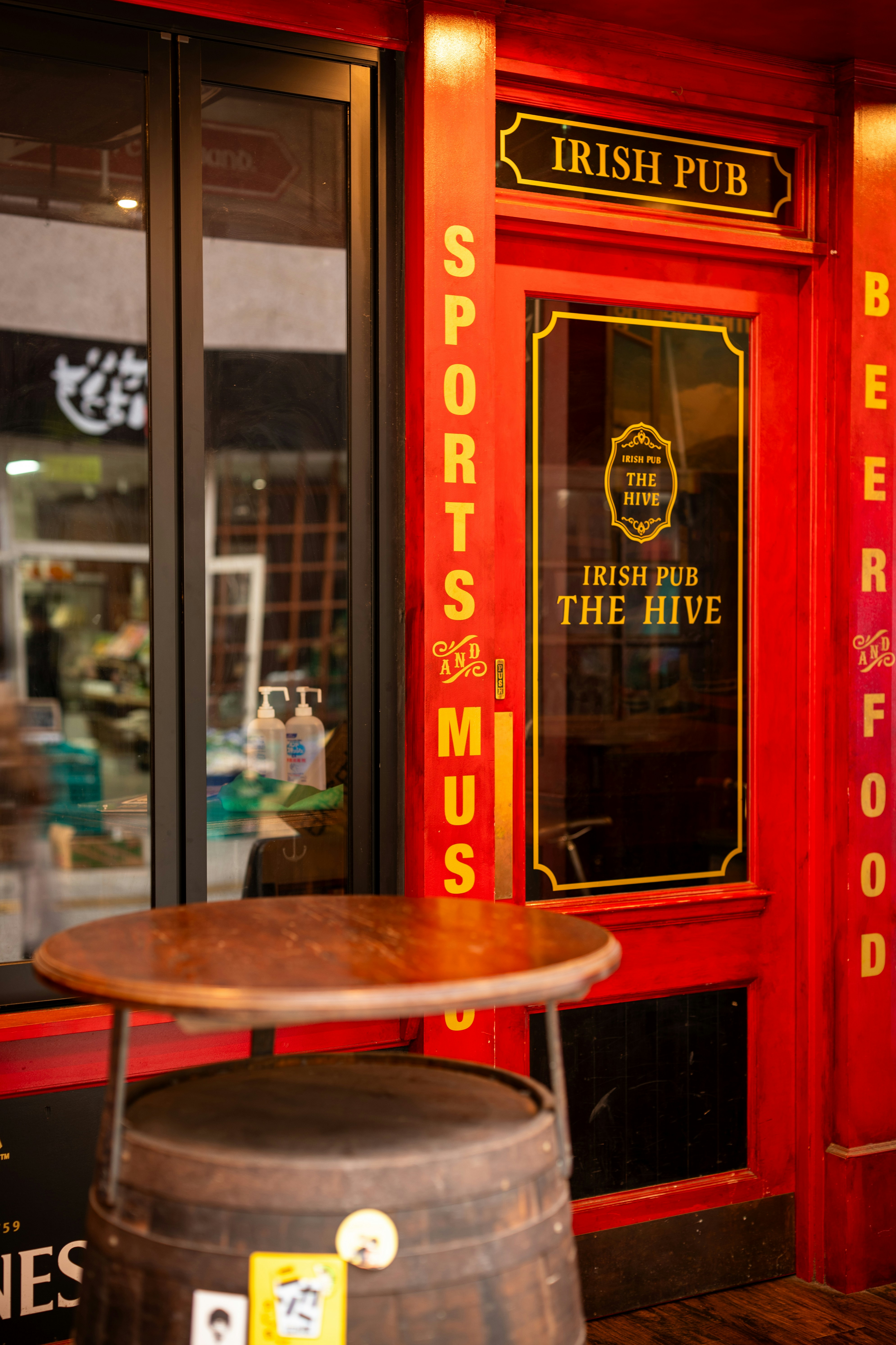 Red-Fronted Irish Pub Facade with Barrel Table Accent