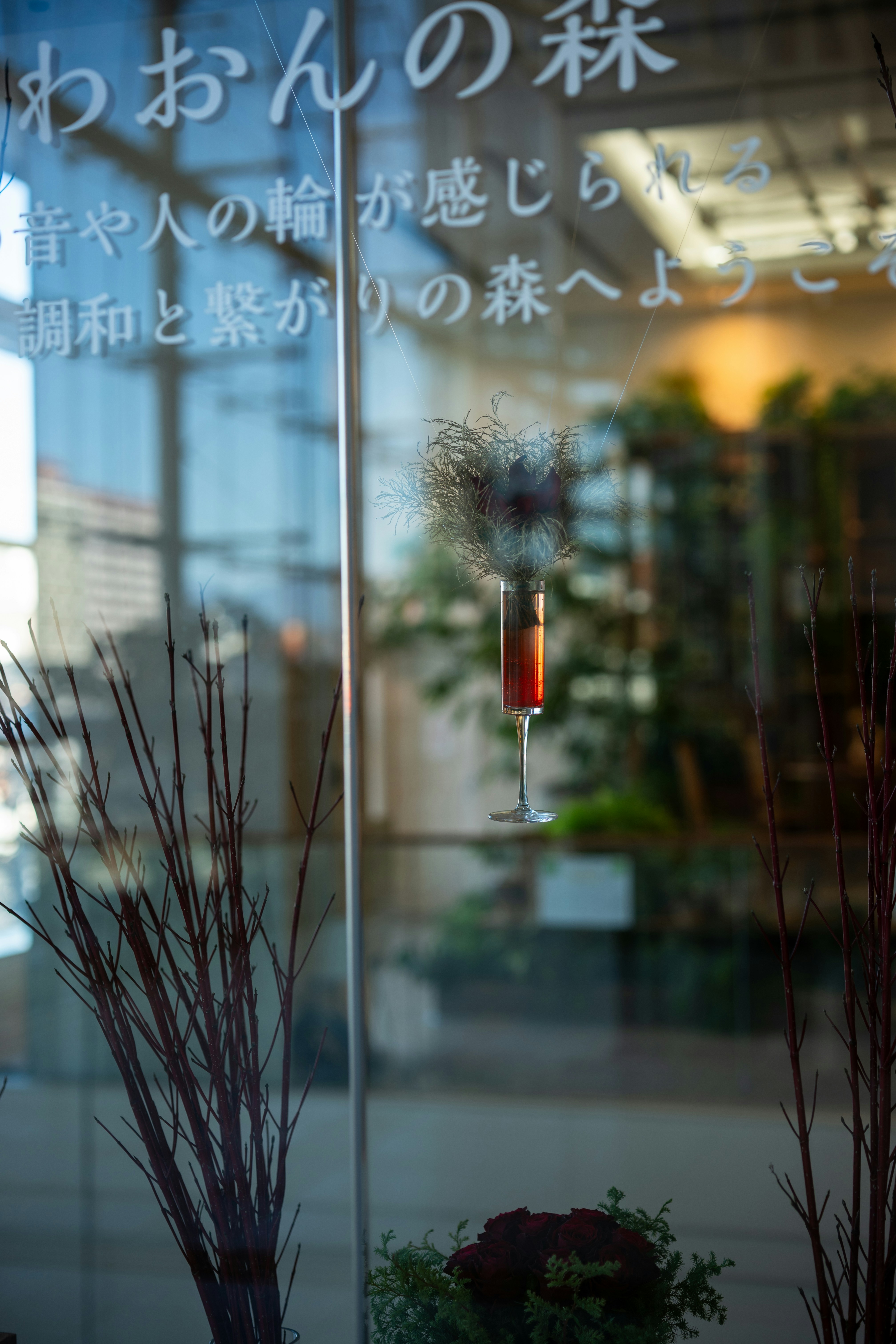 Amber Glass, Feathers and Fragrance: a Suspended Moment in a Studio Window