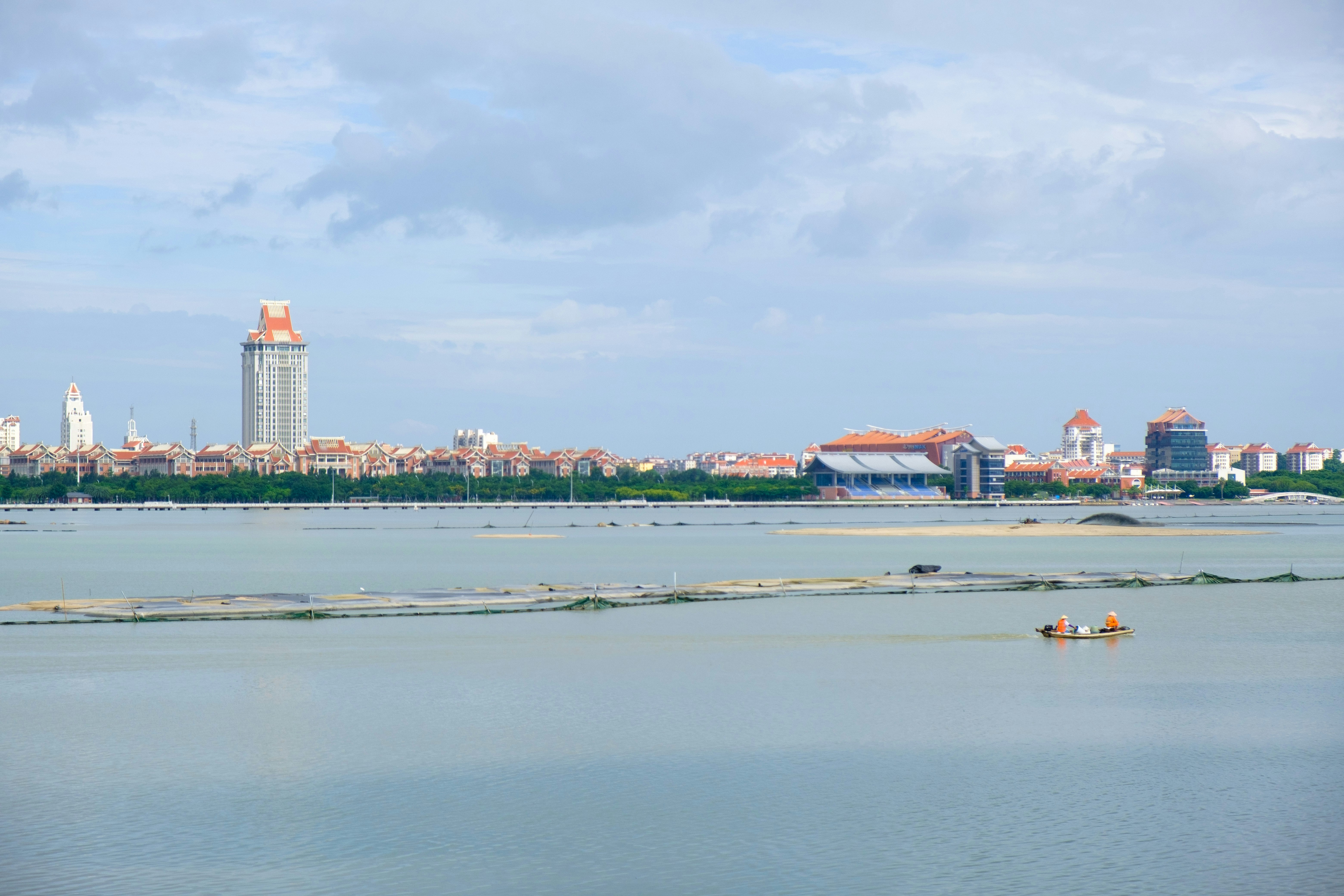 Riverfront Cityscape: A Calm Confluence of Sky, Water, and Towers