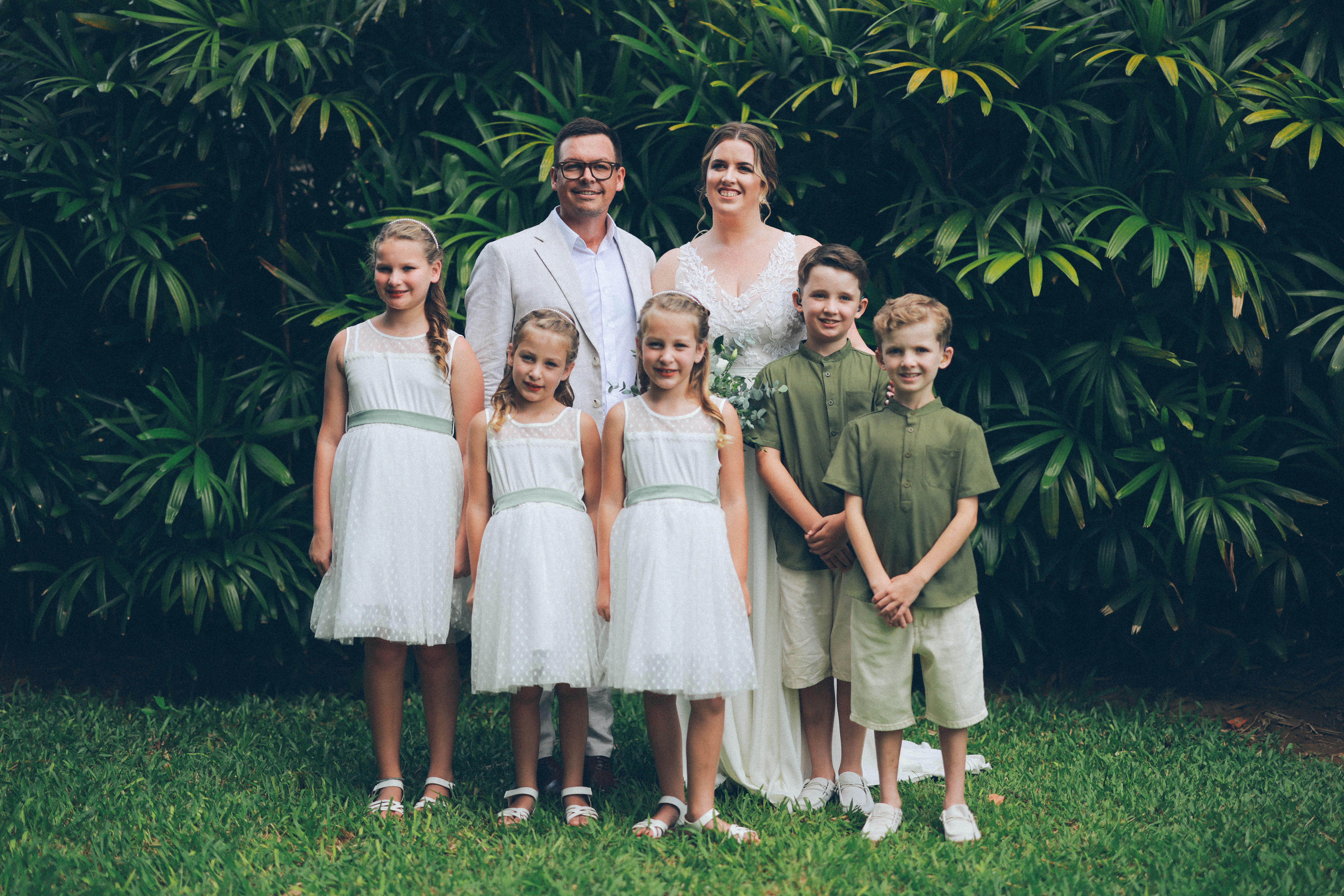 Family Portrait Under Lush Greenery: A Sunny Day Together