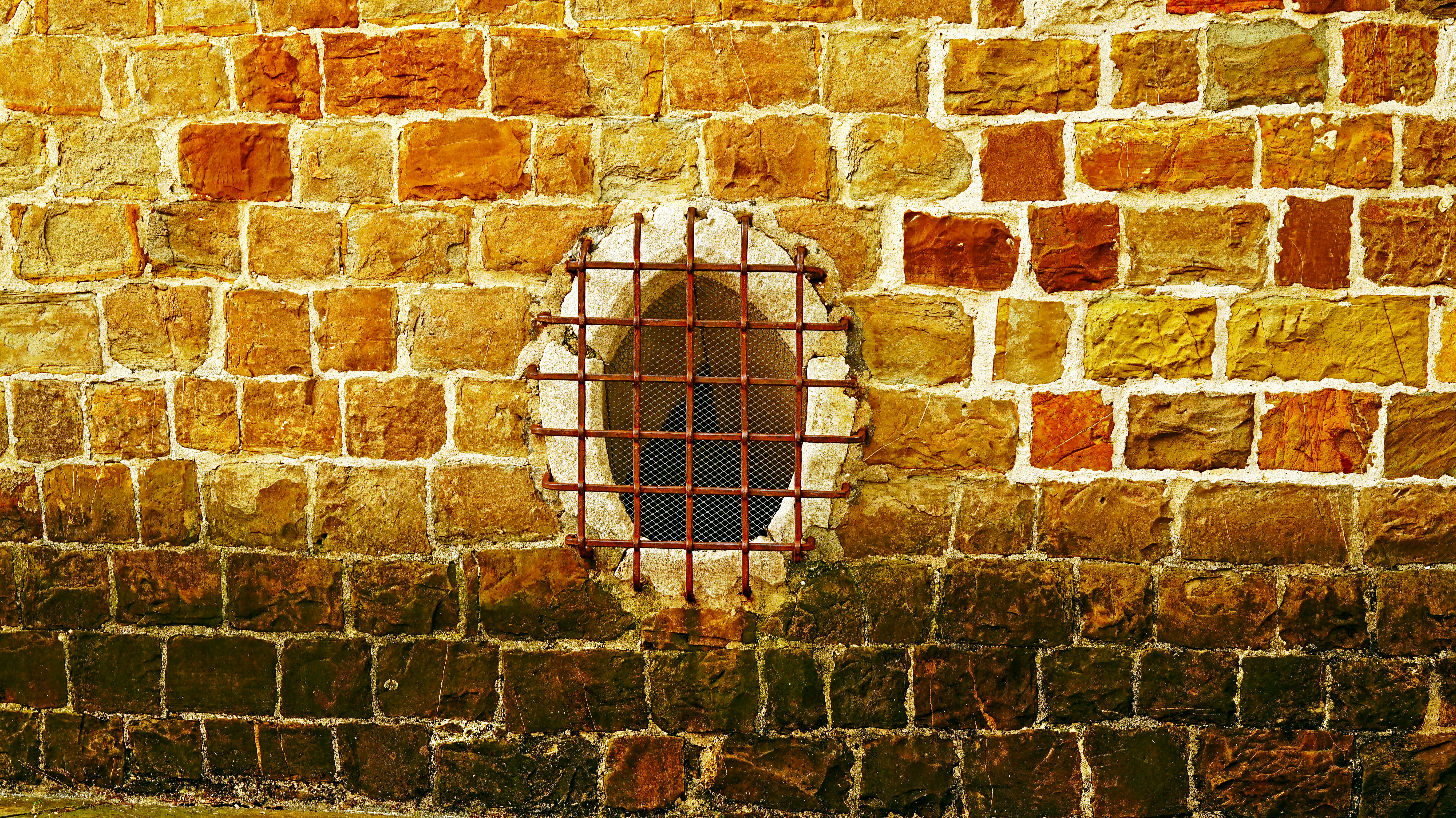 Circular Vent Framed by Weathered Brickwork