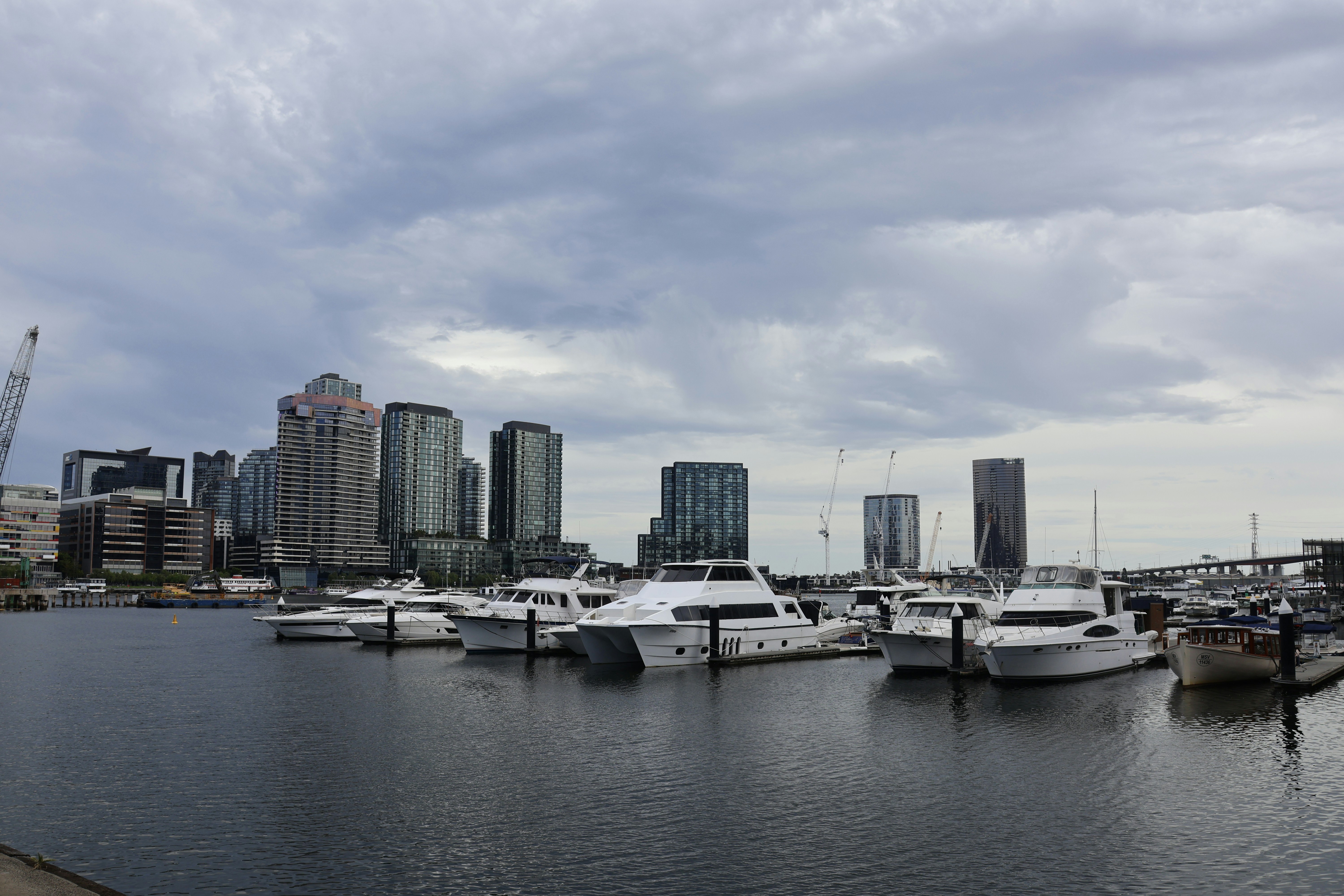 Harbor Reverie: Boats Quietly Docked Under Broad City Sky