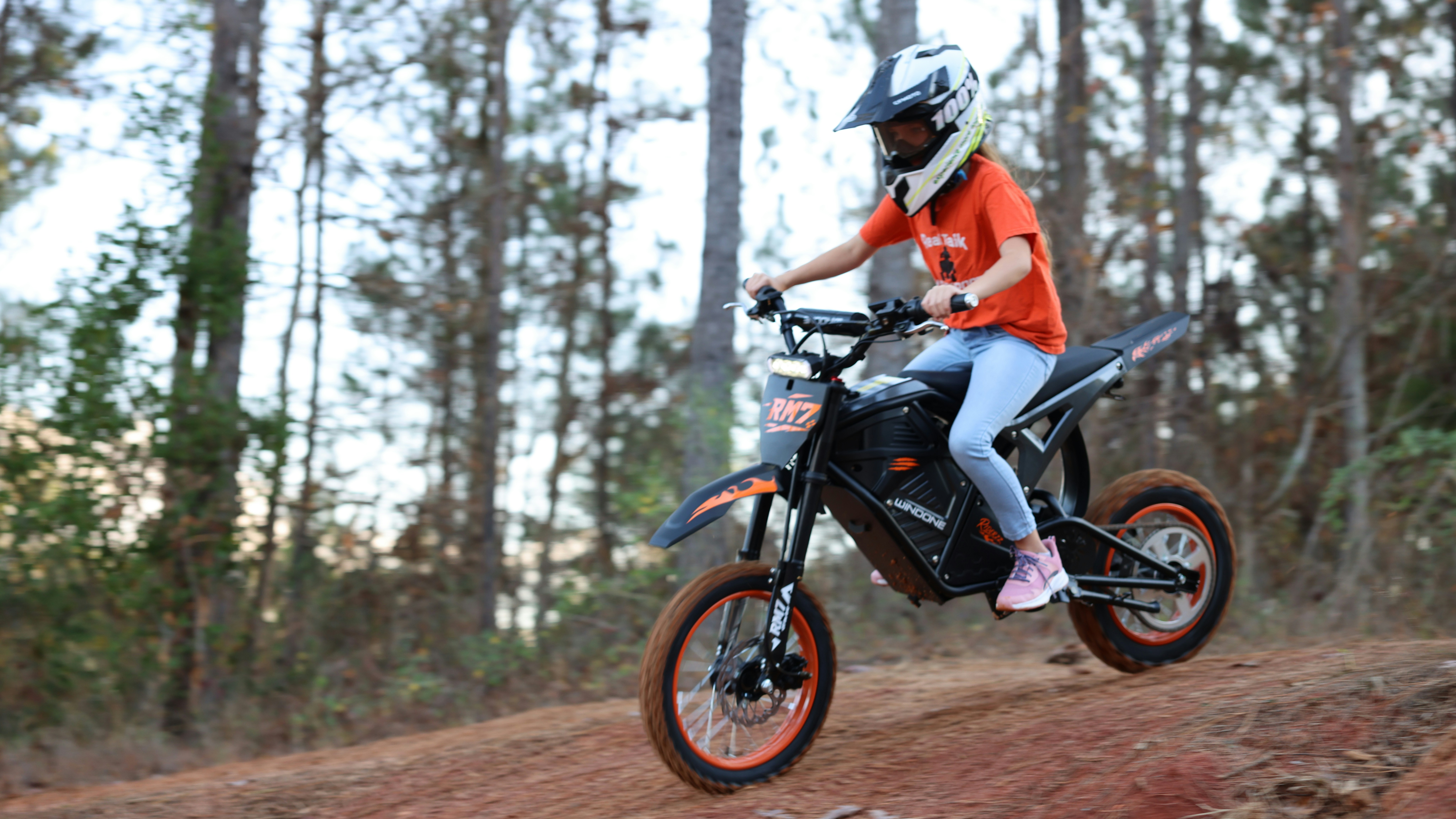 Rider in Flight: Orange Trail Burst