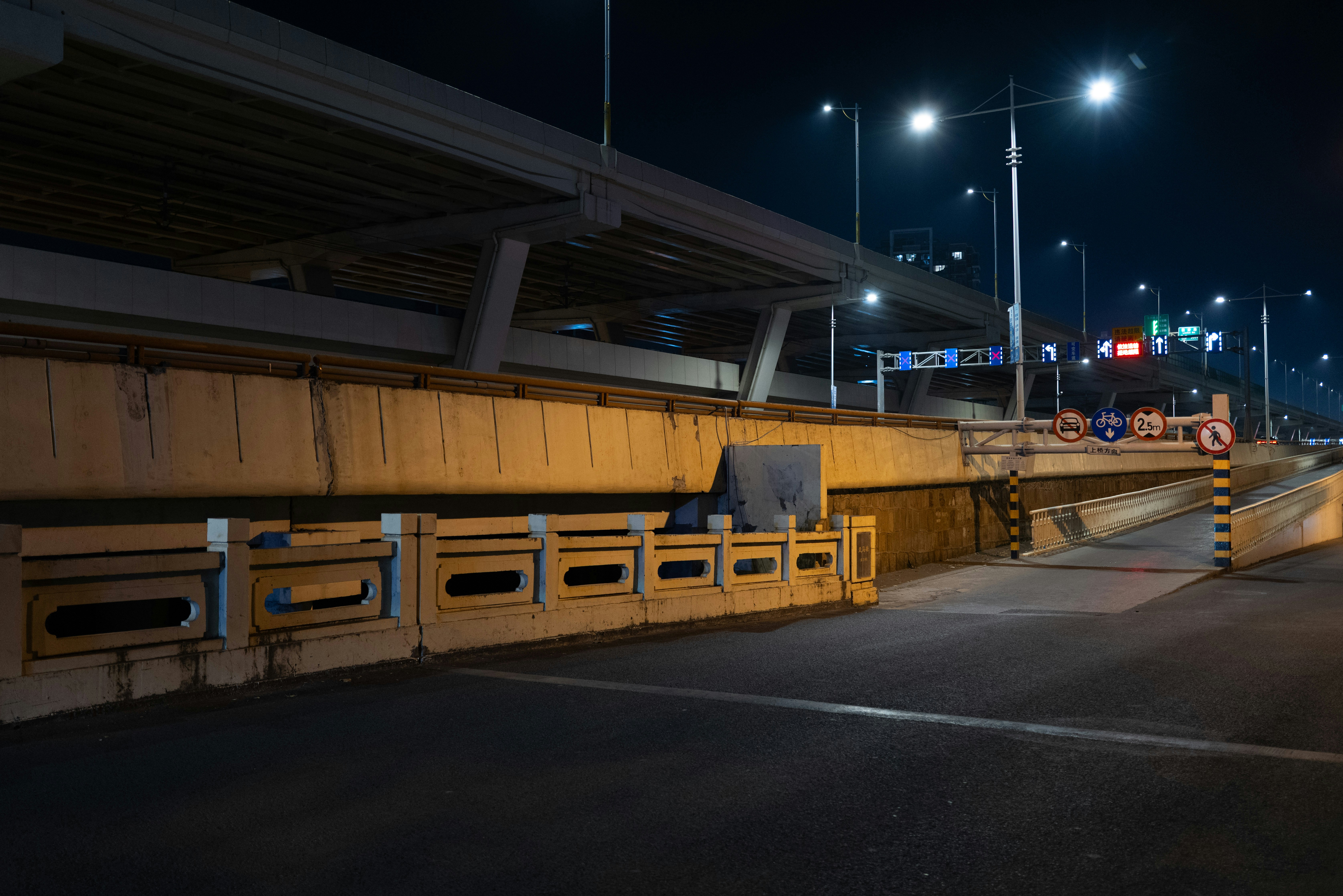 Night Route: Concrete Barriers and Underpass Lights