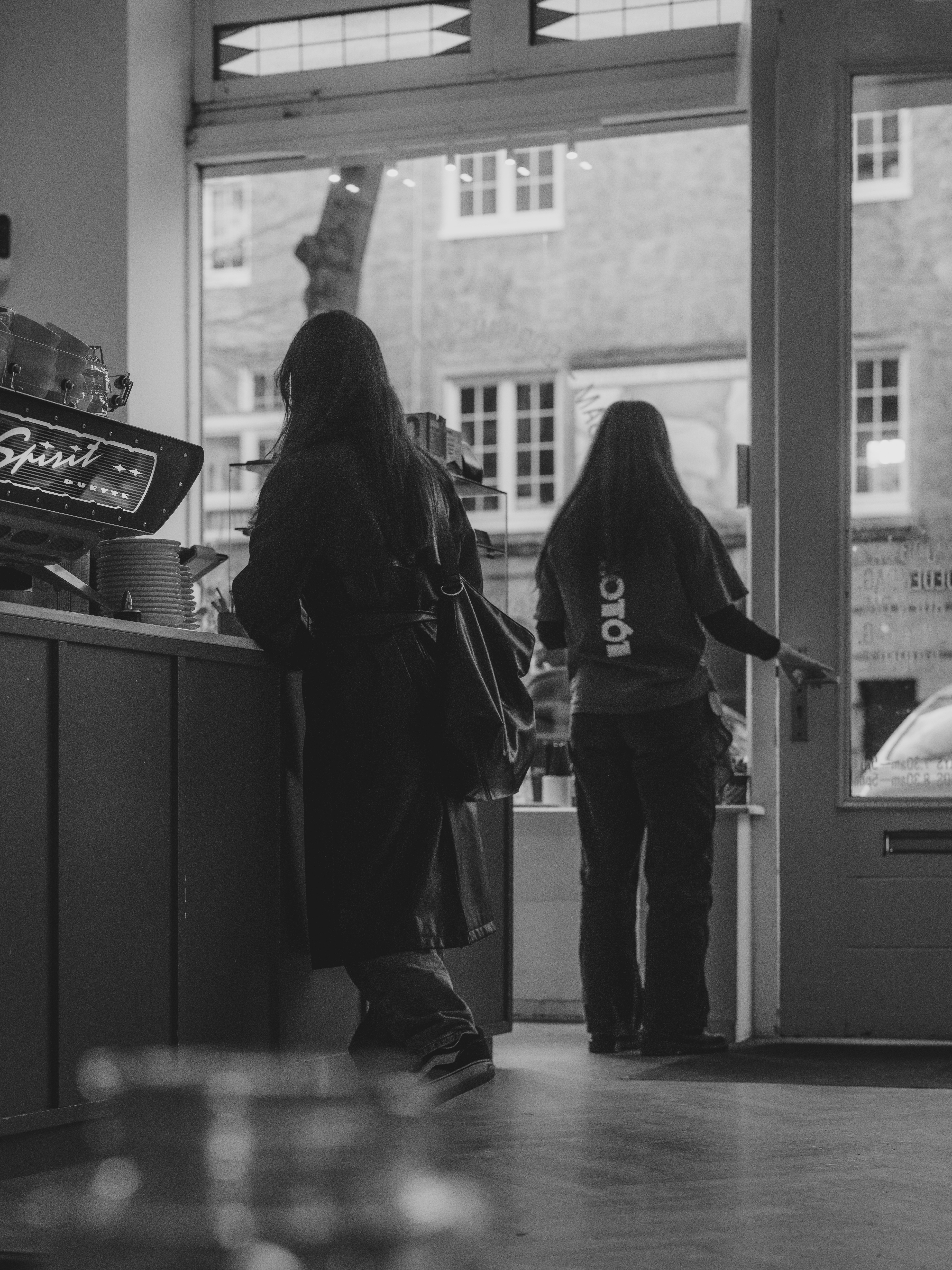 Quiet Corner: Two Figures in Line for Coffee