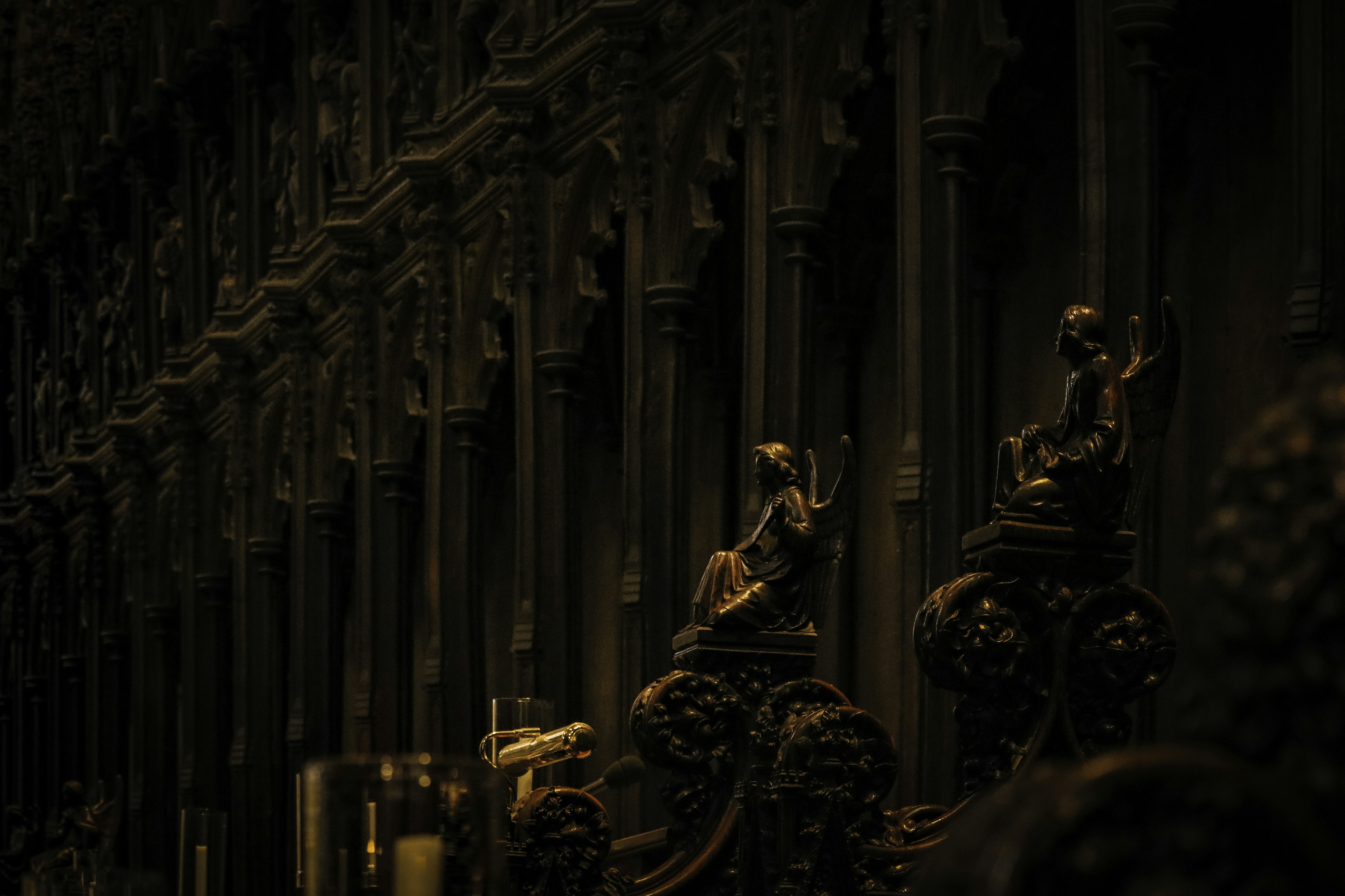 Intricate dark ornate carvings with small statues