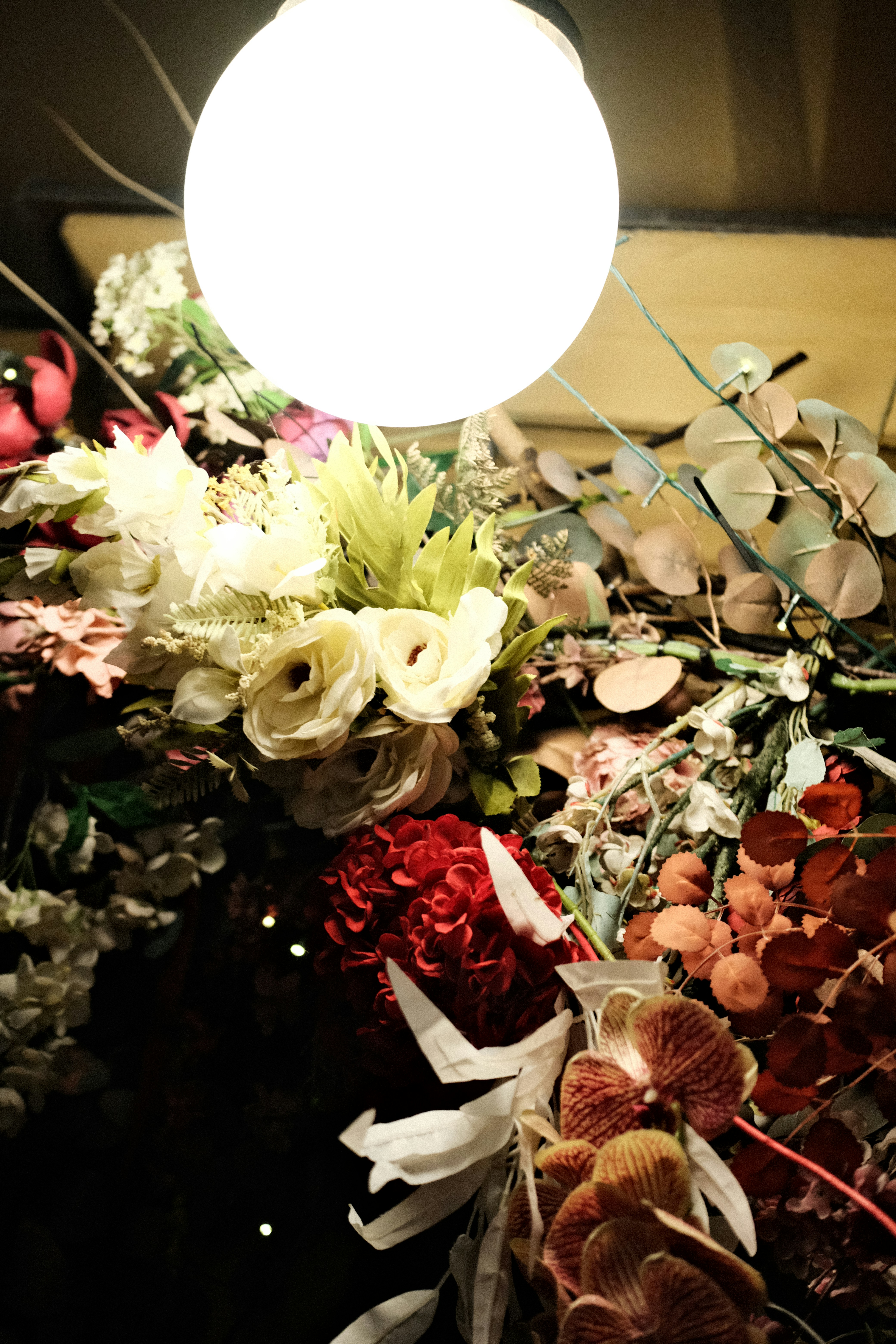 Overhead Glow: Floral Arrangement Beneath a Floating Lantern