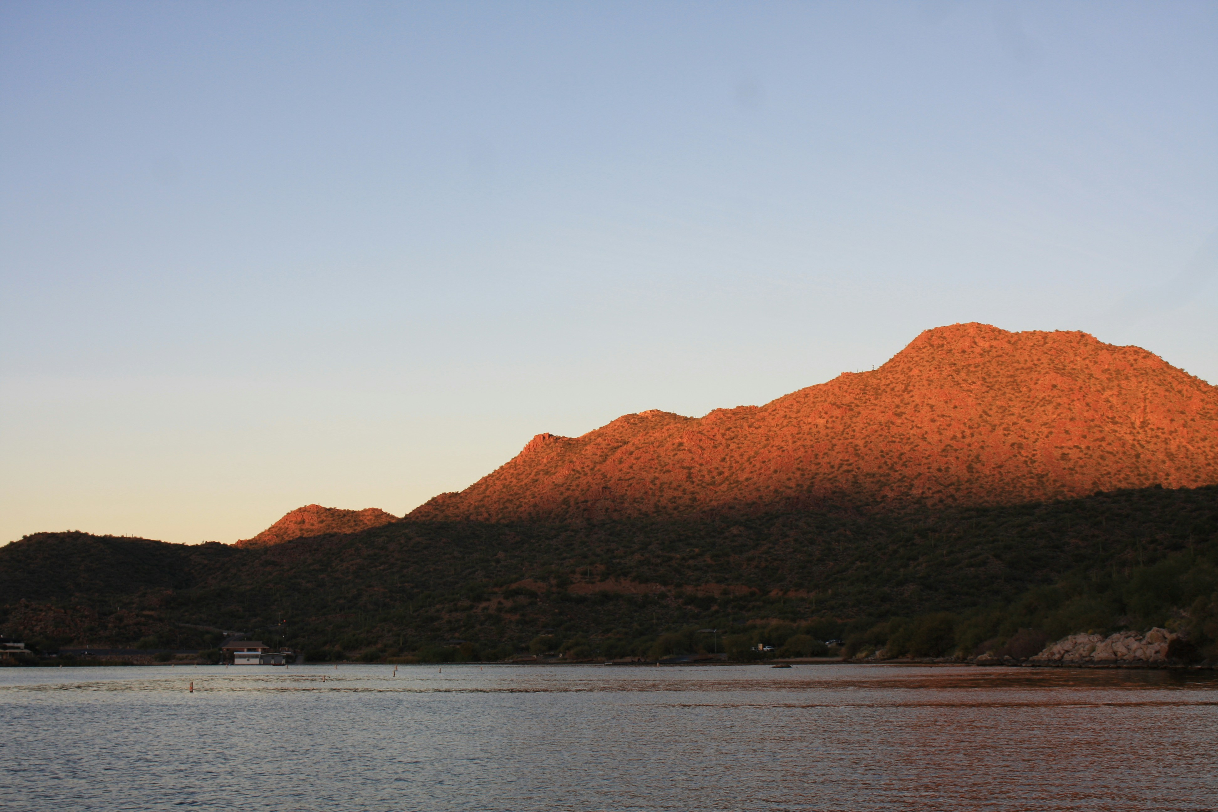 Golden Ridge at Dusk Over Calm Waterfront