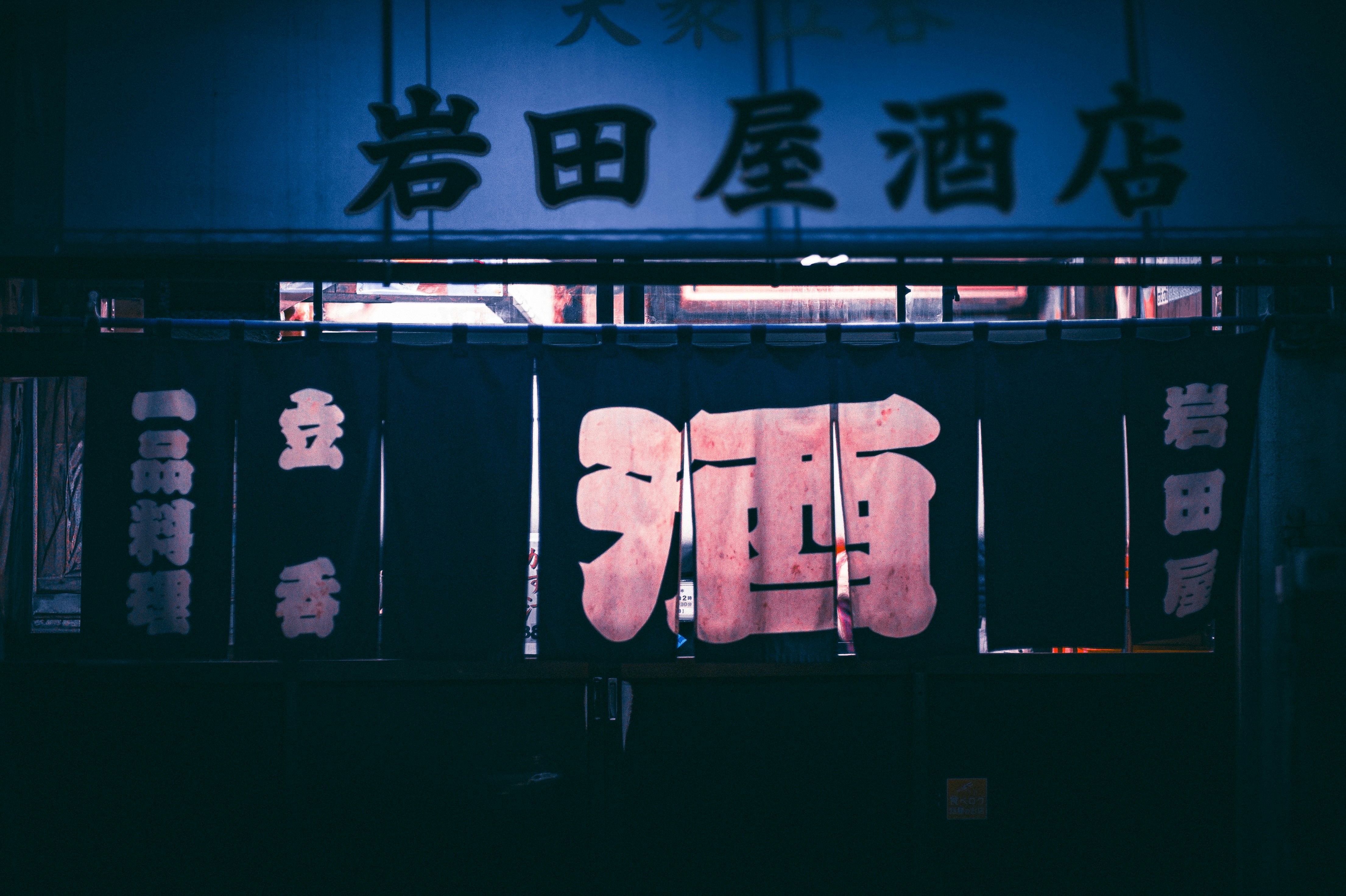 Neon Glimmer Behind Fabric: A Quiet Tokyo Night Sign