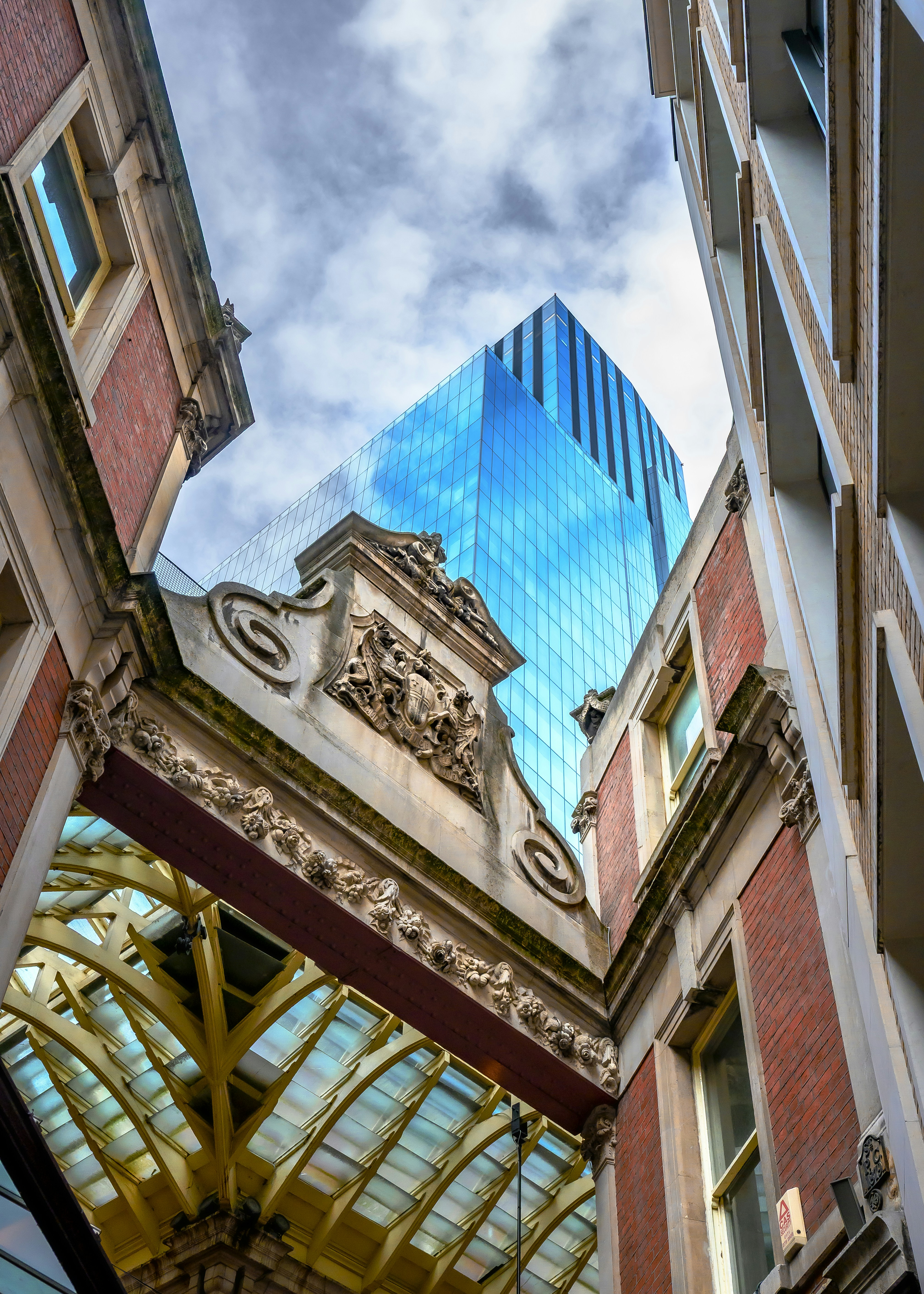 Ascending Glass: Heritage Arch Framing a Skyward Glass Tower