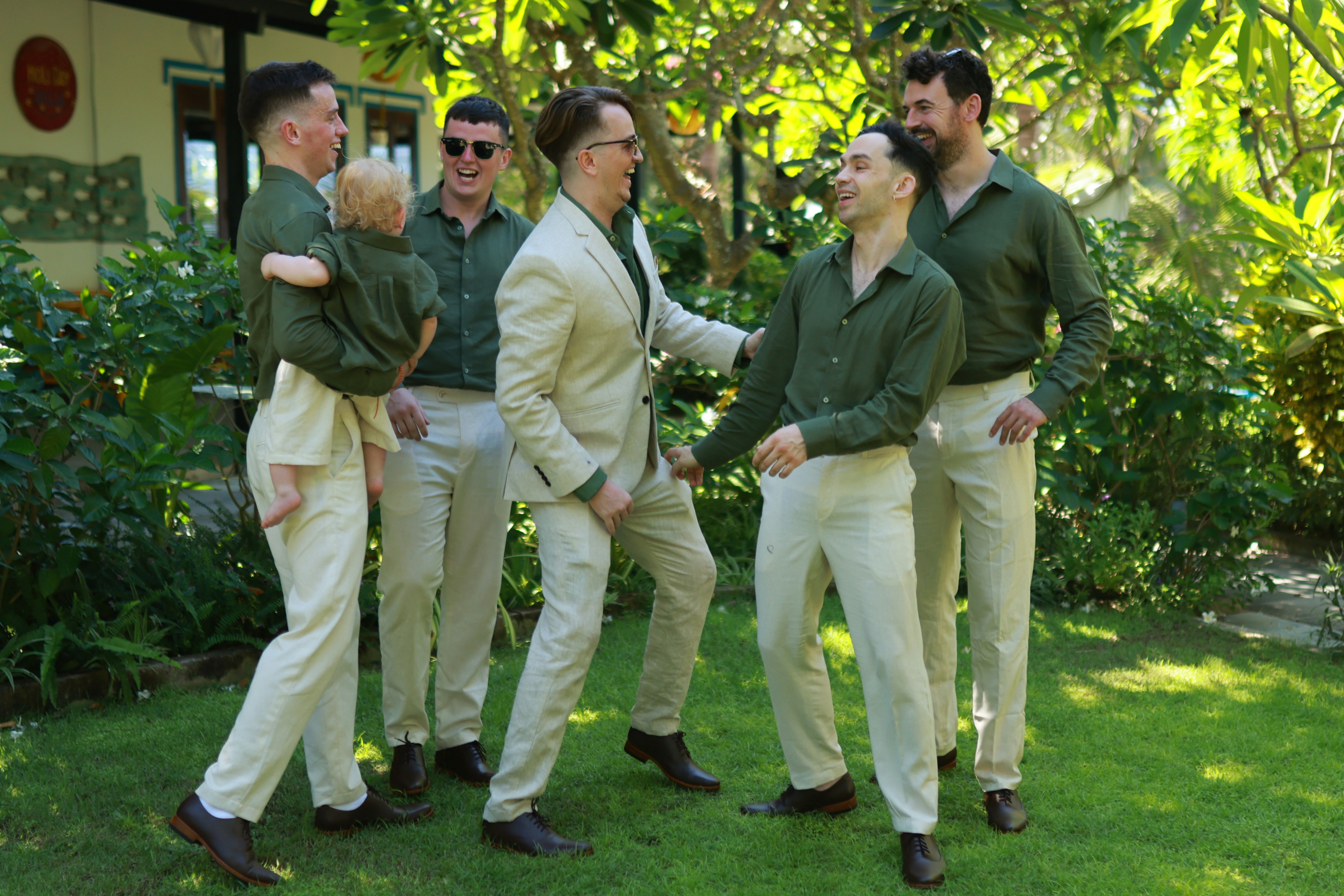 Sunlit Groom Party: Gentlemen in Coordinated Earth Tones Share a Laugh