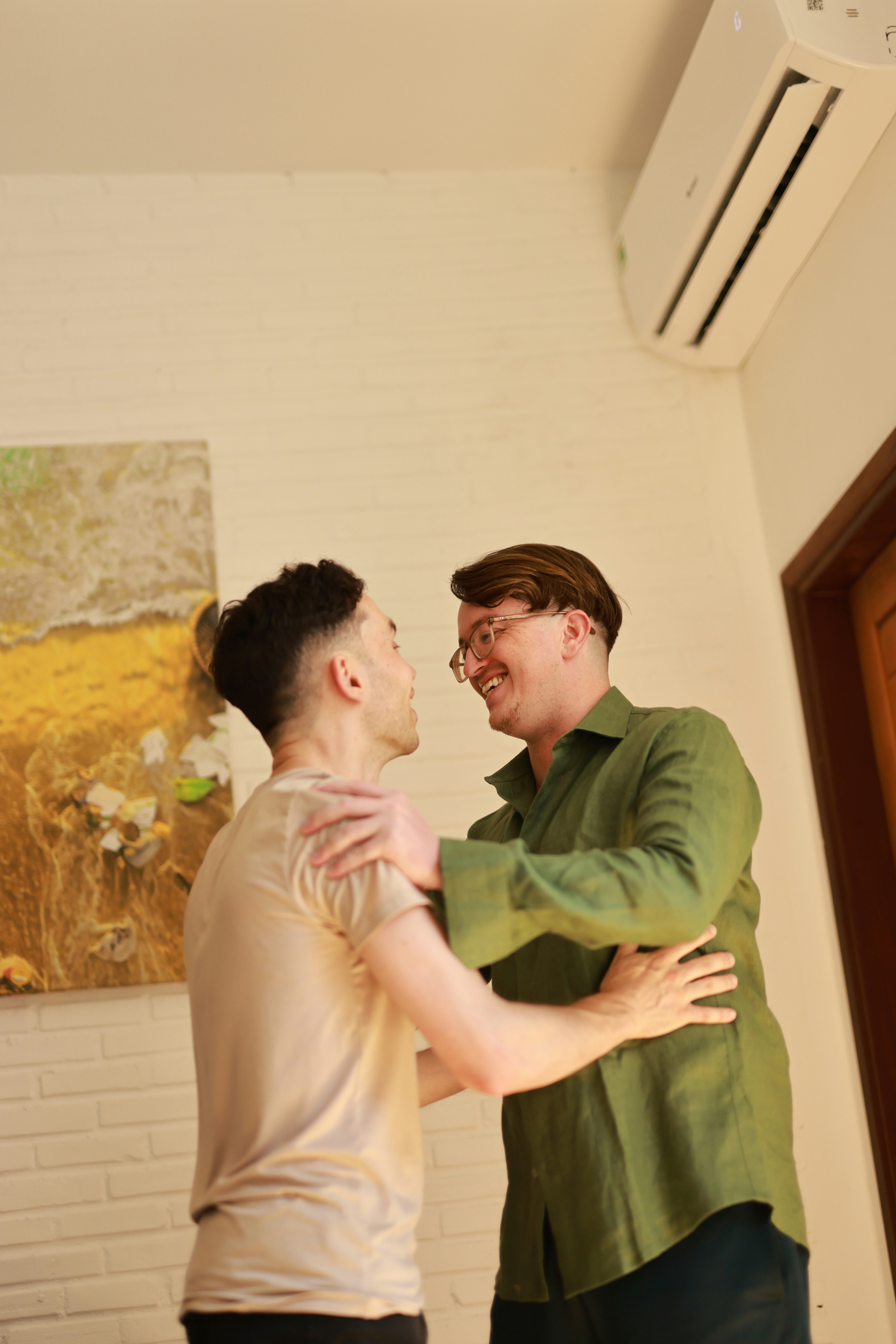 Two Friends in a Warm Embrace: A Candid Living Room Moment