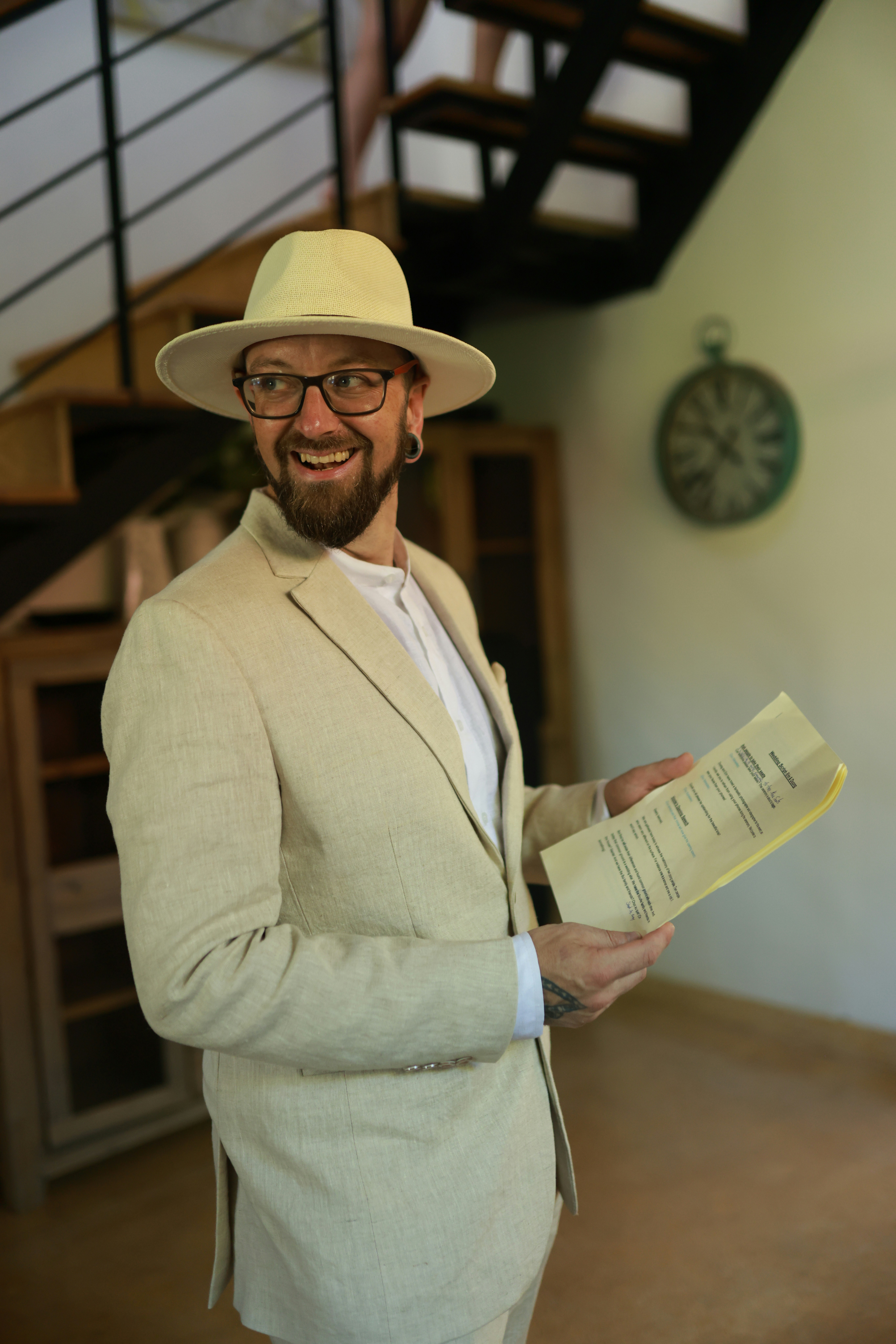 Gentleman in a Linen Suit Reads Aloud in Warm Indoor Light