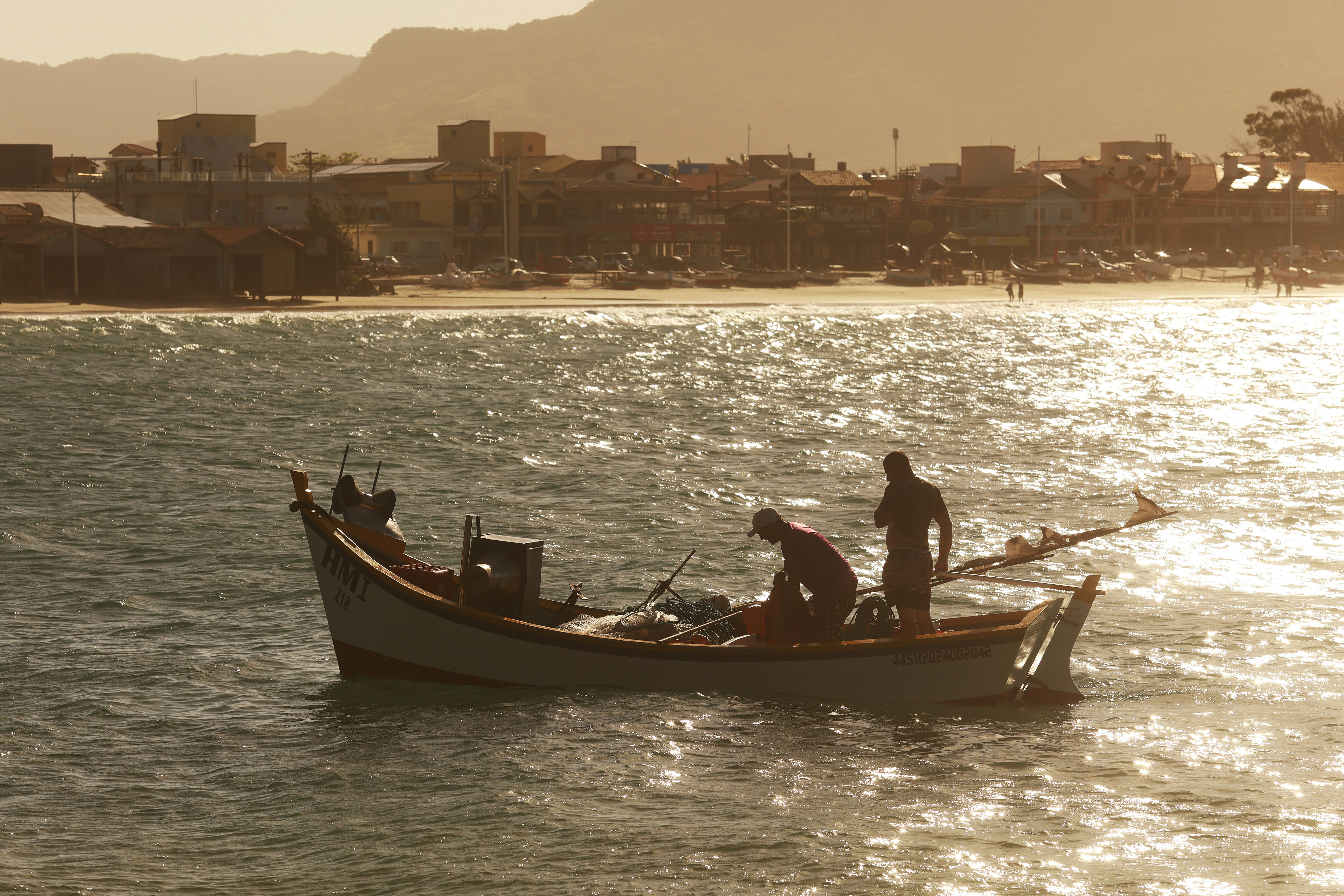 Fishing boat in Garopaba's sunset. Garopaba, SC, Brasil.