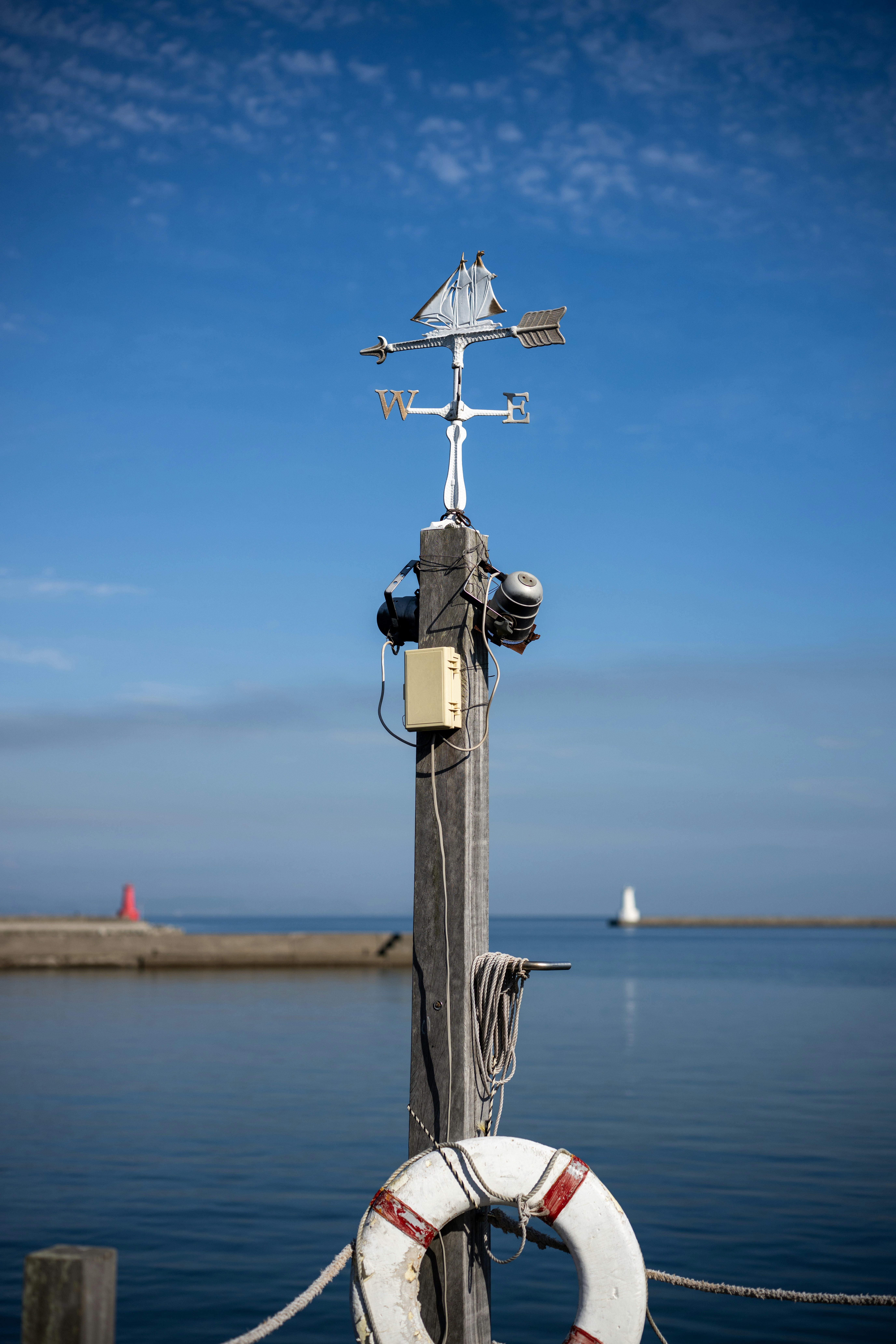 Harbor Beacon: Weathered Weathervane Above a Seaside Post