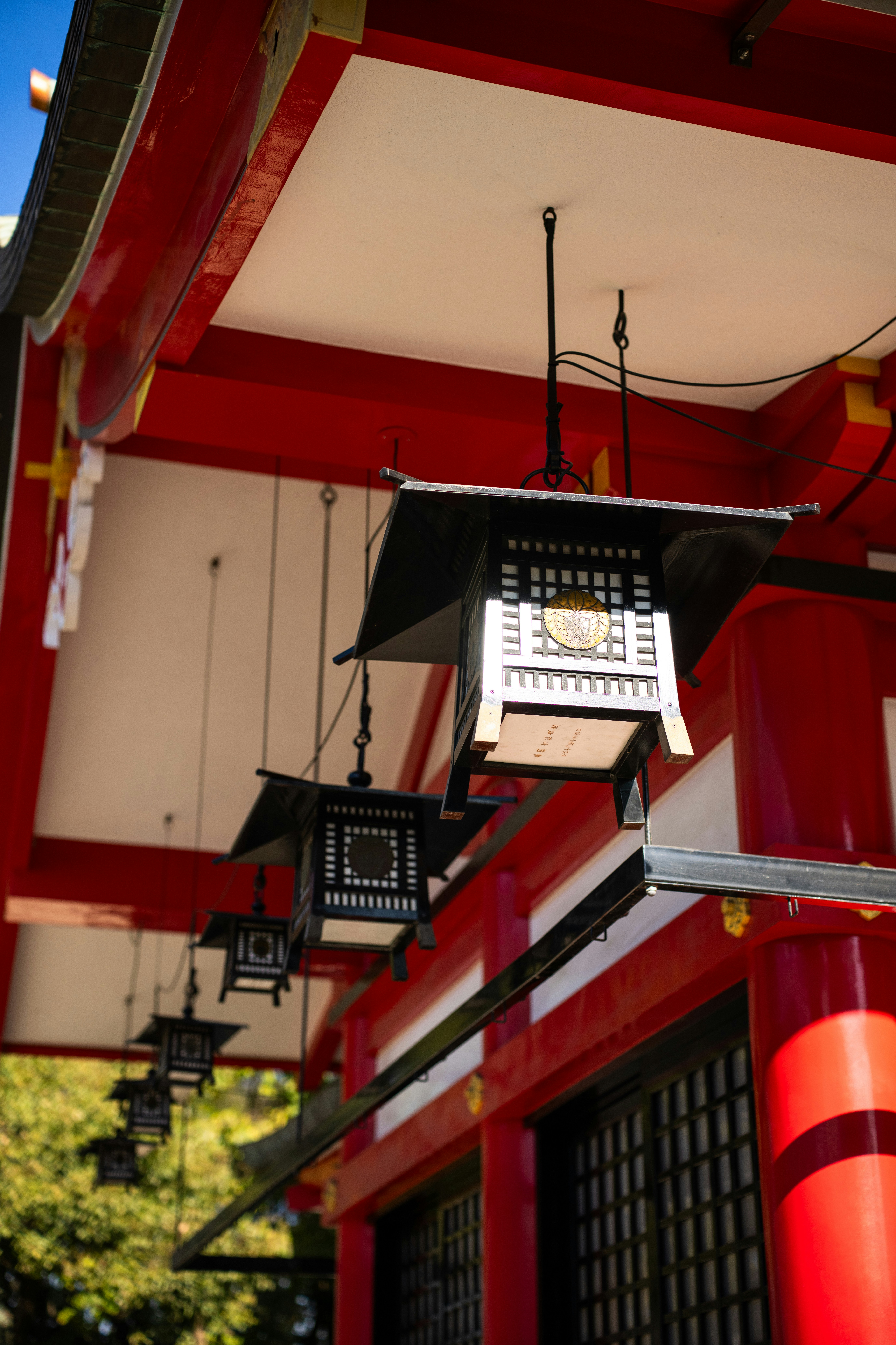 Hanging Lanterns Along a Red-Columned Corridor