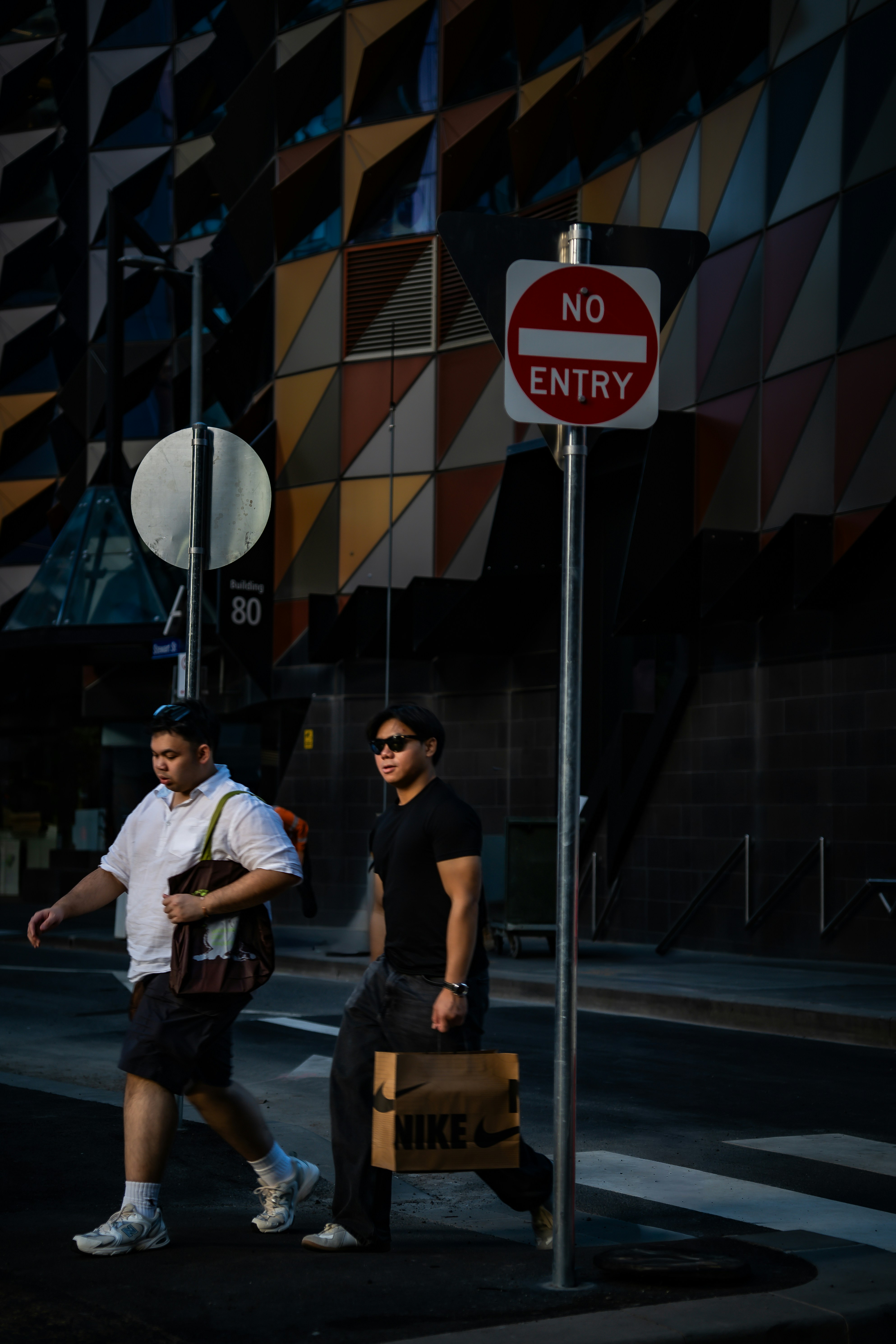 Urban Shadow: A Stylistic Street Portrait by the No Entry Sign