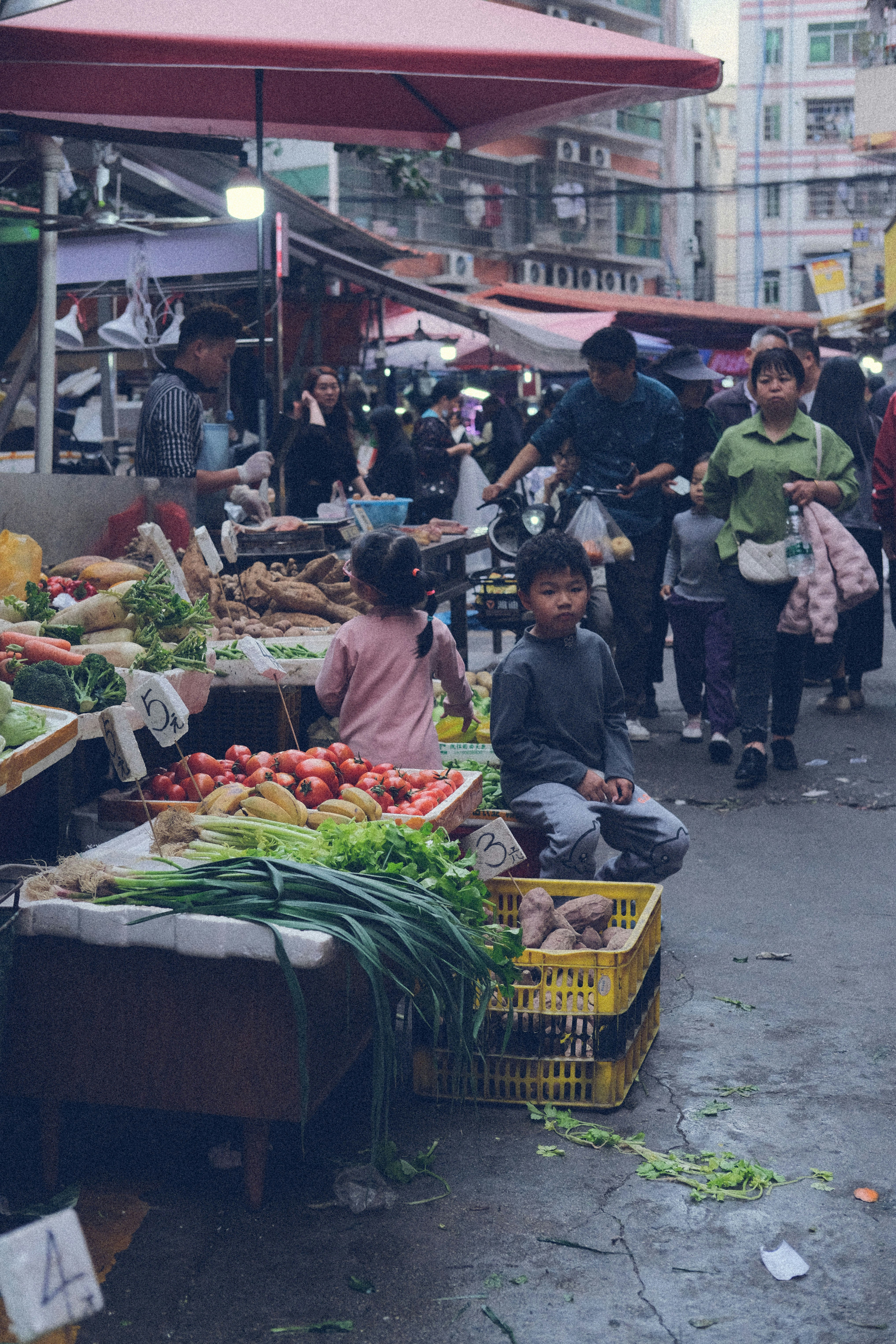 Chinese Street Food Market, Guangzhou | China 🇨🇳 Experience the lively atmosphere of a traditional Chinese wet market in Guangzhou, Guangdong Province. This photo captures everyday locals shopping for ultra-fresh produce: stacks of vibrant tropical fruits including dragon fruit, mangoes, lychees, and pomelo, alongside heaps of green leafy vegetables such as choy sum, water spinach, and bitter melon. Guangzhou's street food markets are famous for their incredible variety and freshness, offering a glimpse into authentic Cantonese culinary culture. Perfect spot for foodies and travelers seek