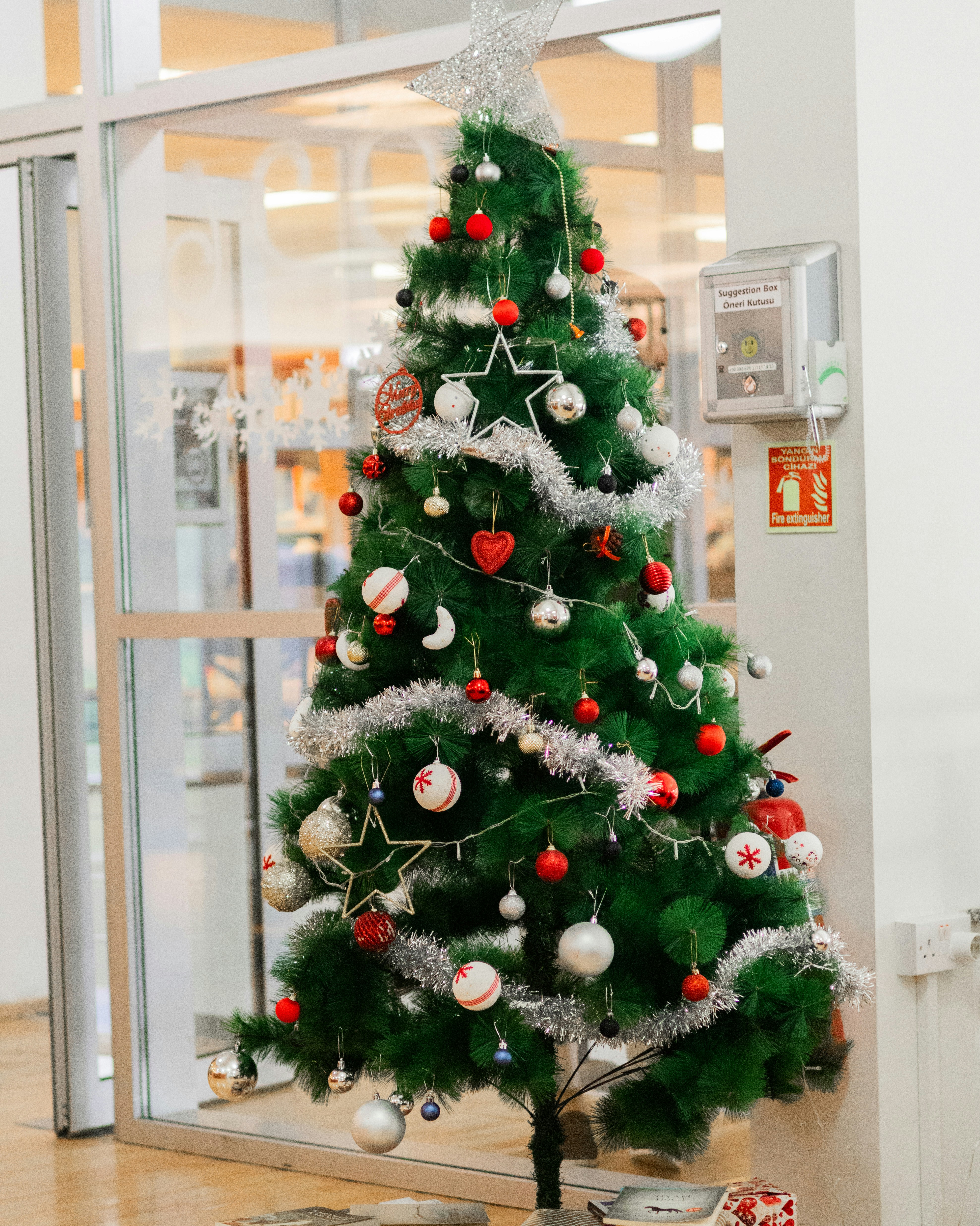 Festive Tree Glimmering Inside a Bright Lobby