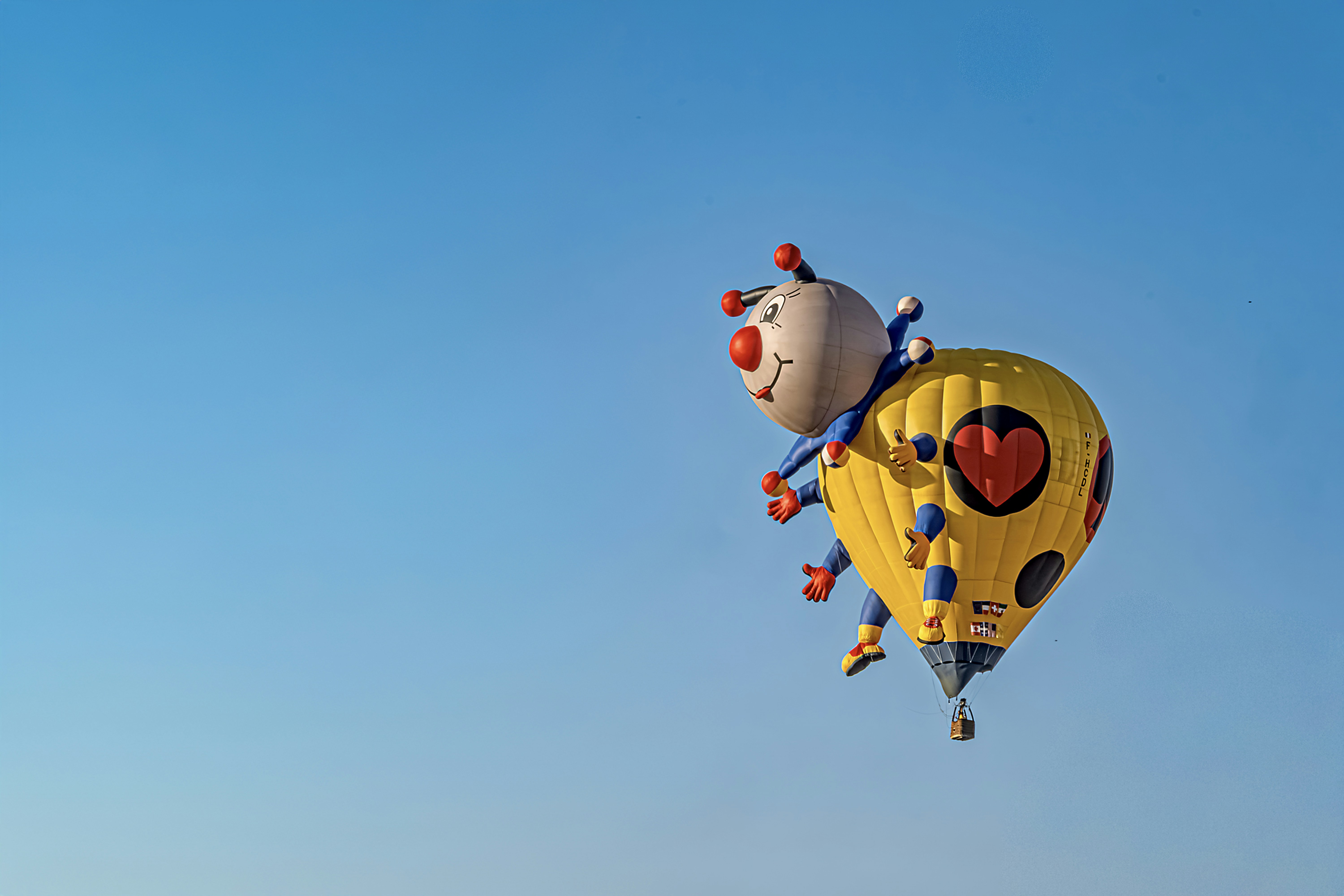 A Balloon Acrobat Soars Against a Clear Blue Canvas