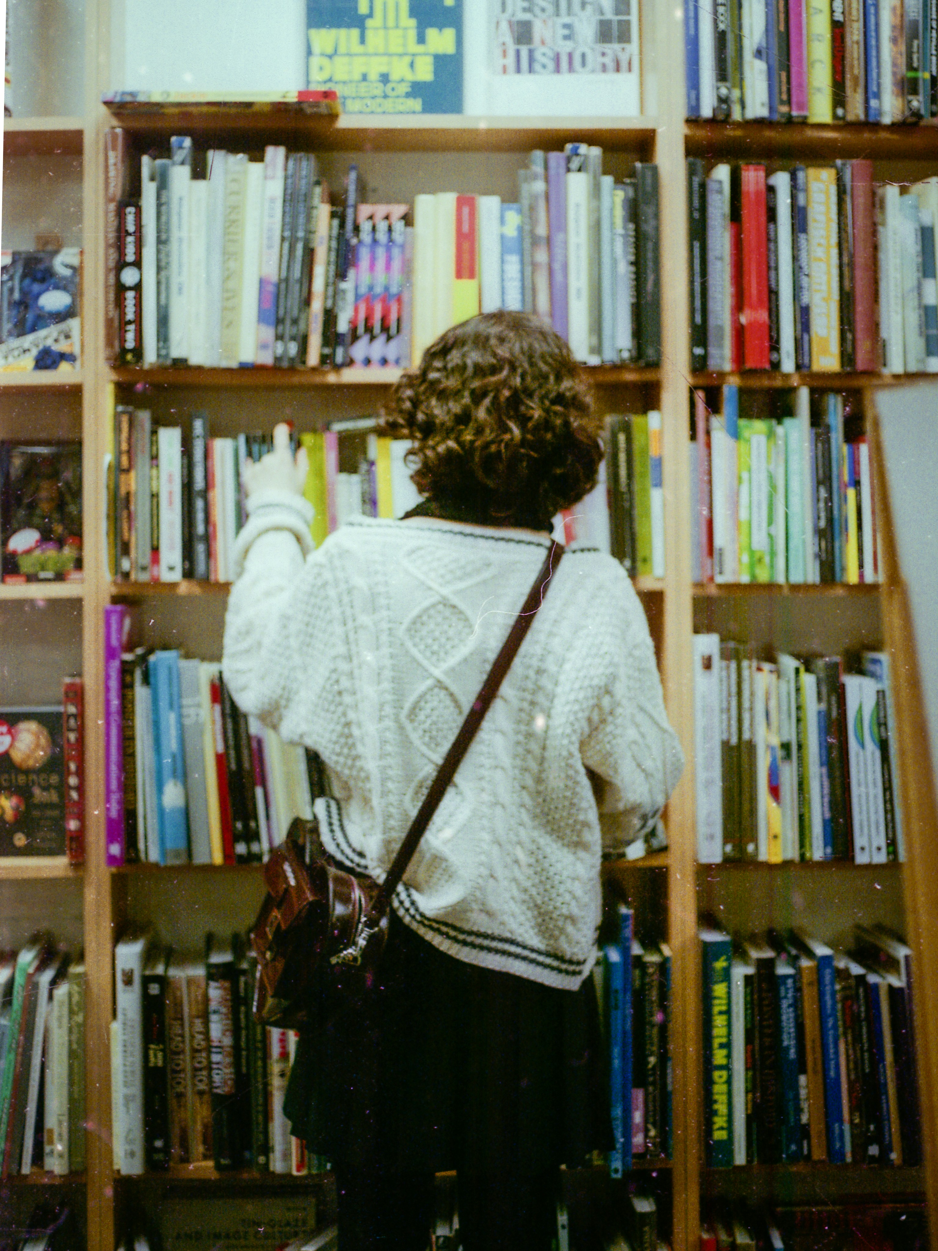 Woman browsing books on a shelf photo – Free Books Image on Unsplash