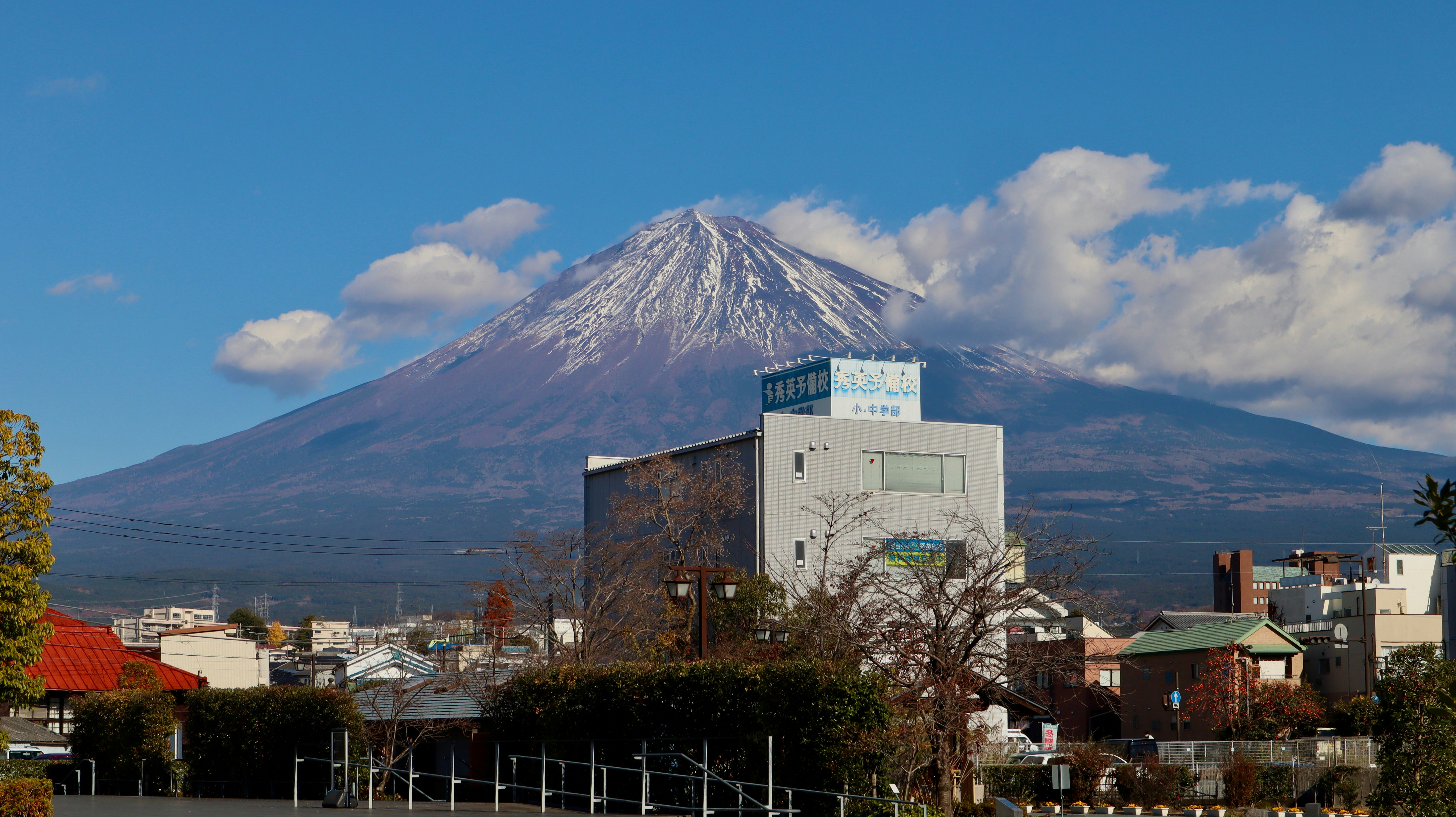 Snow-Capped Peak Over a Quiet Cityscape