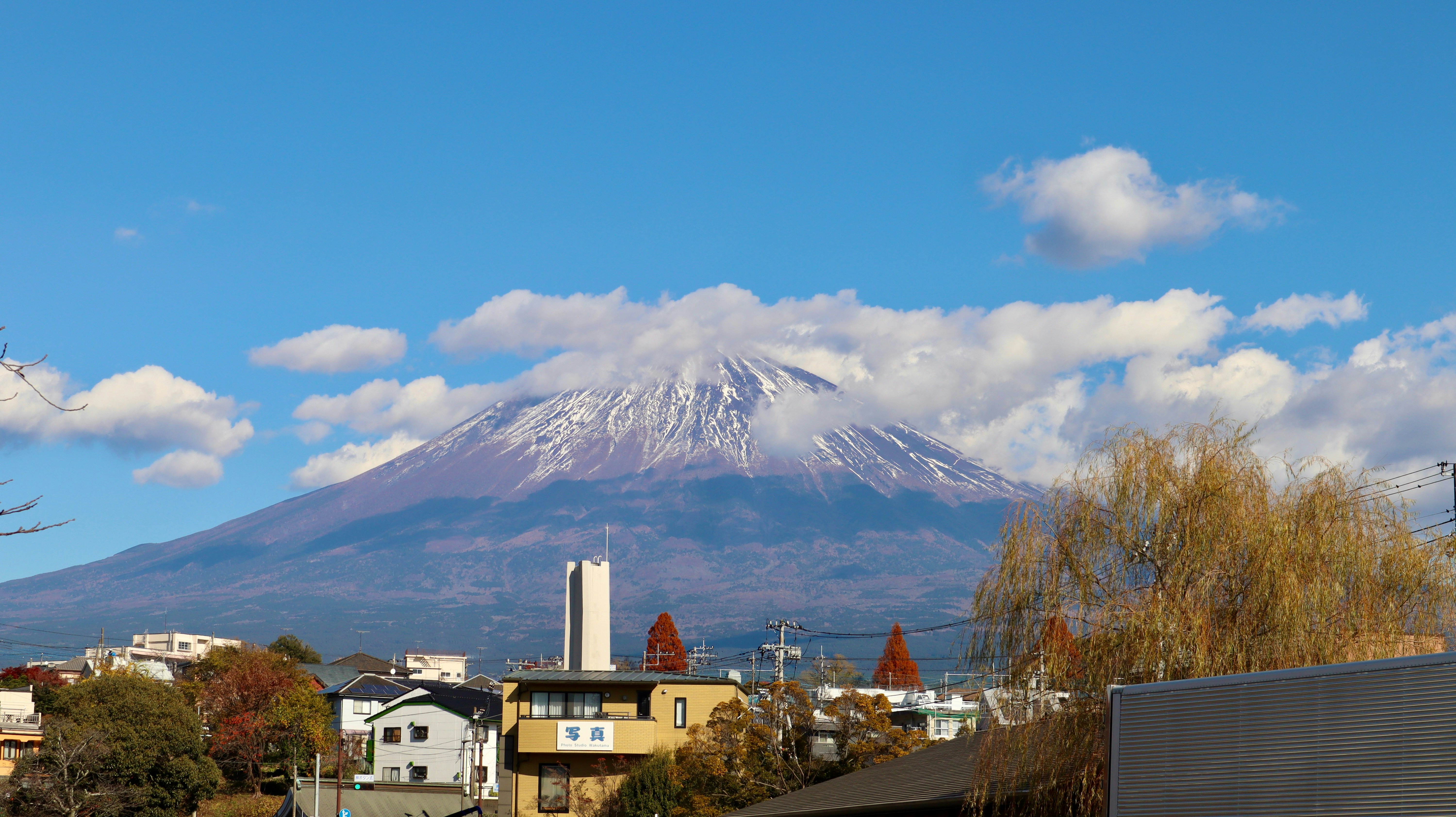 Snow-kissed Volcano Over Suburban Quiet