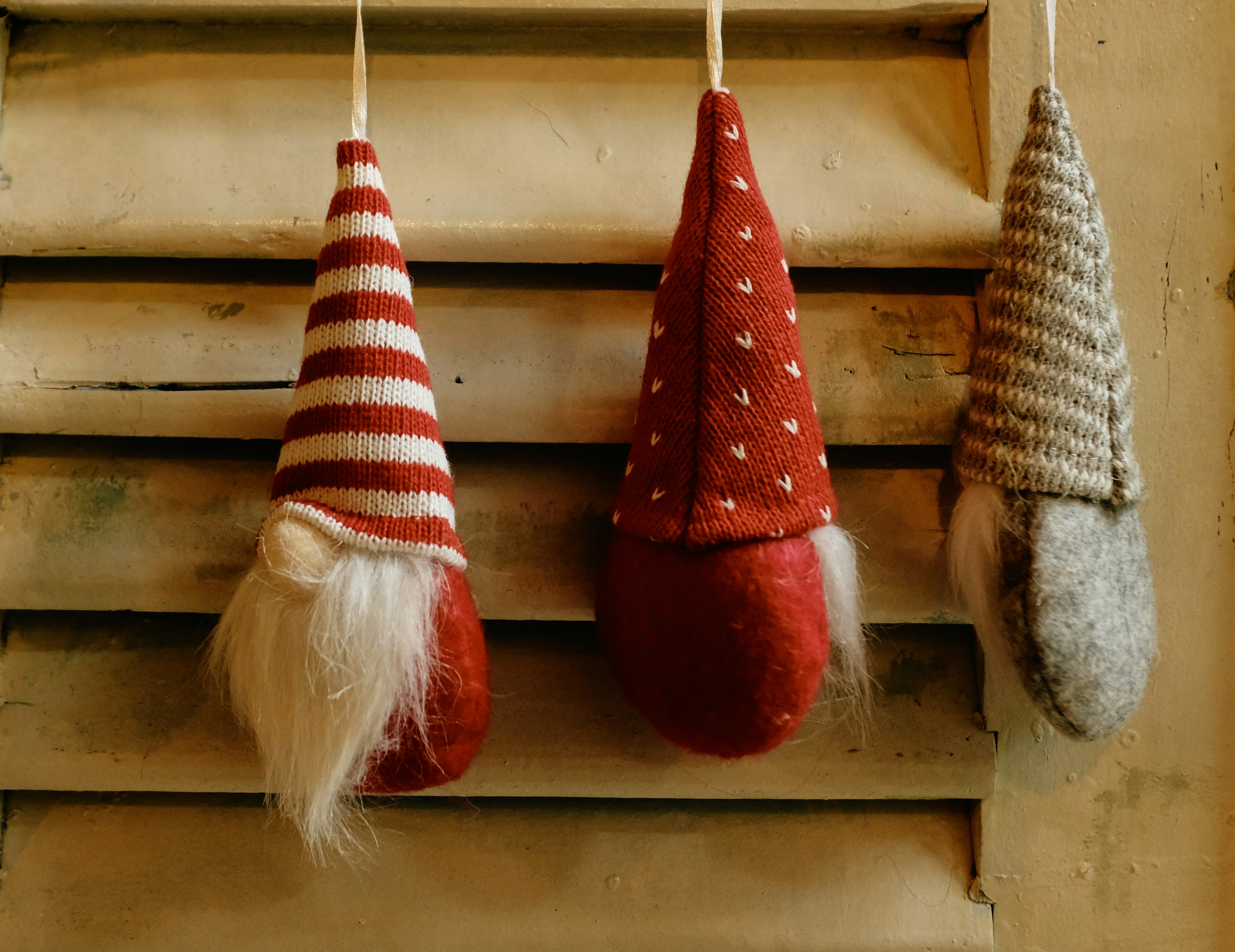 Three Felted Gnomes Guard a Rustic Window