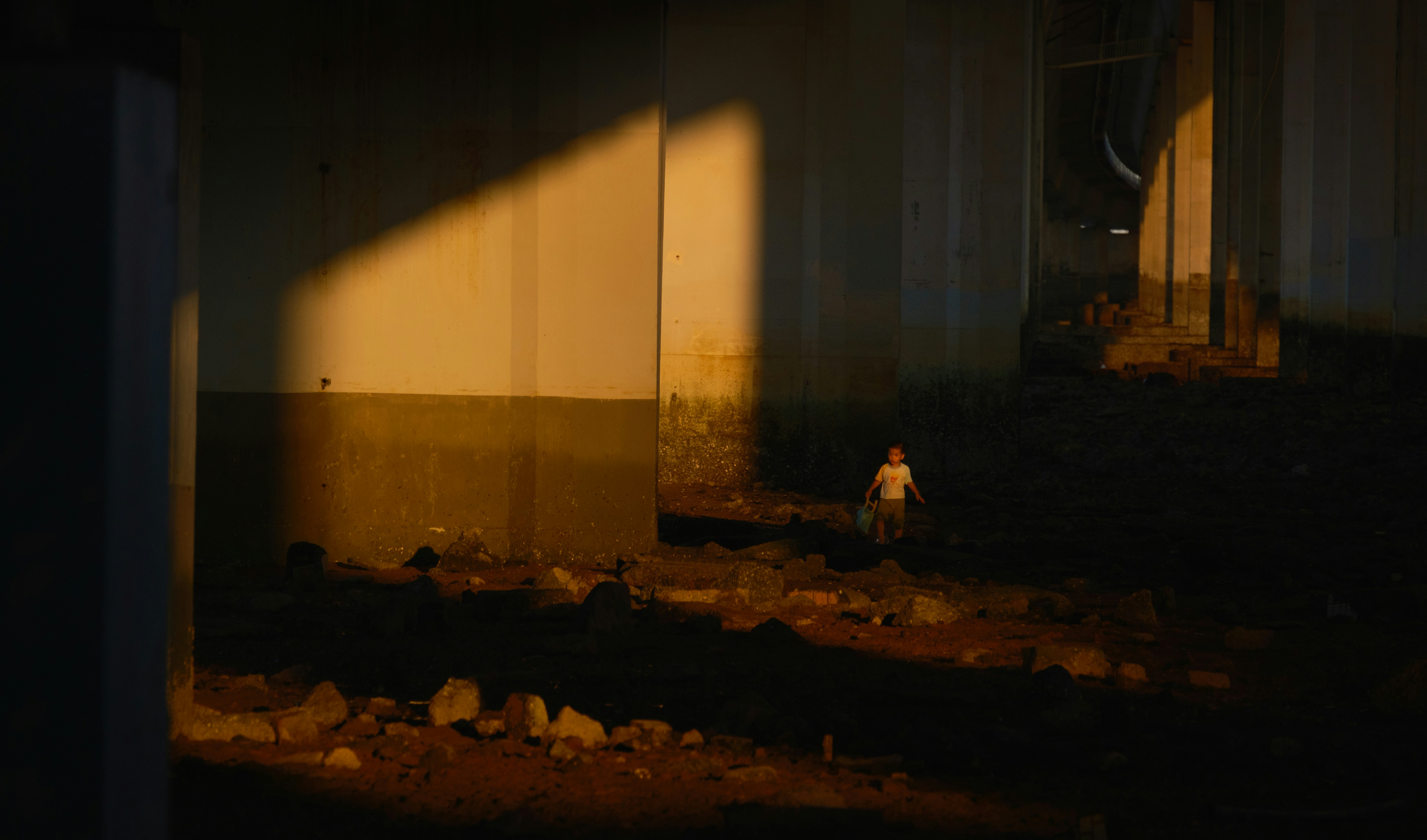 Shadowed Figure Under the Pier: A Solitary Scene at Dusk