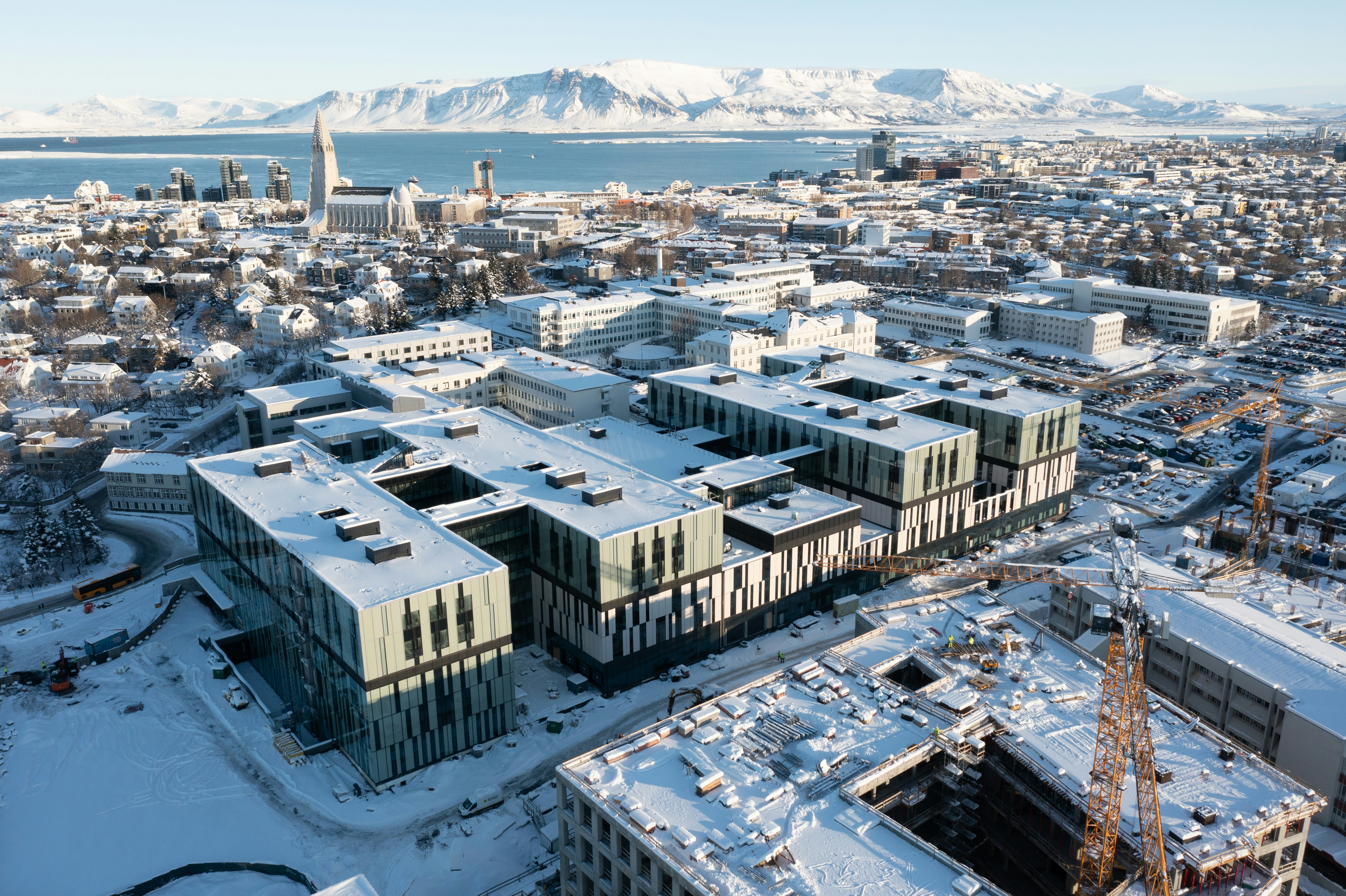 Icebound Campus: Aerial Glimmer over Snow-Covered Modern Blocks