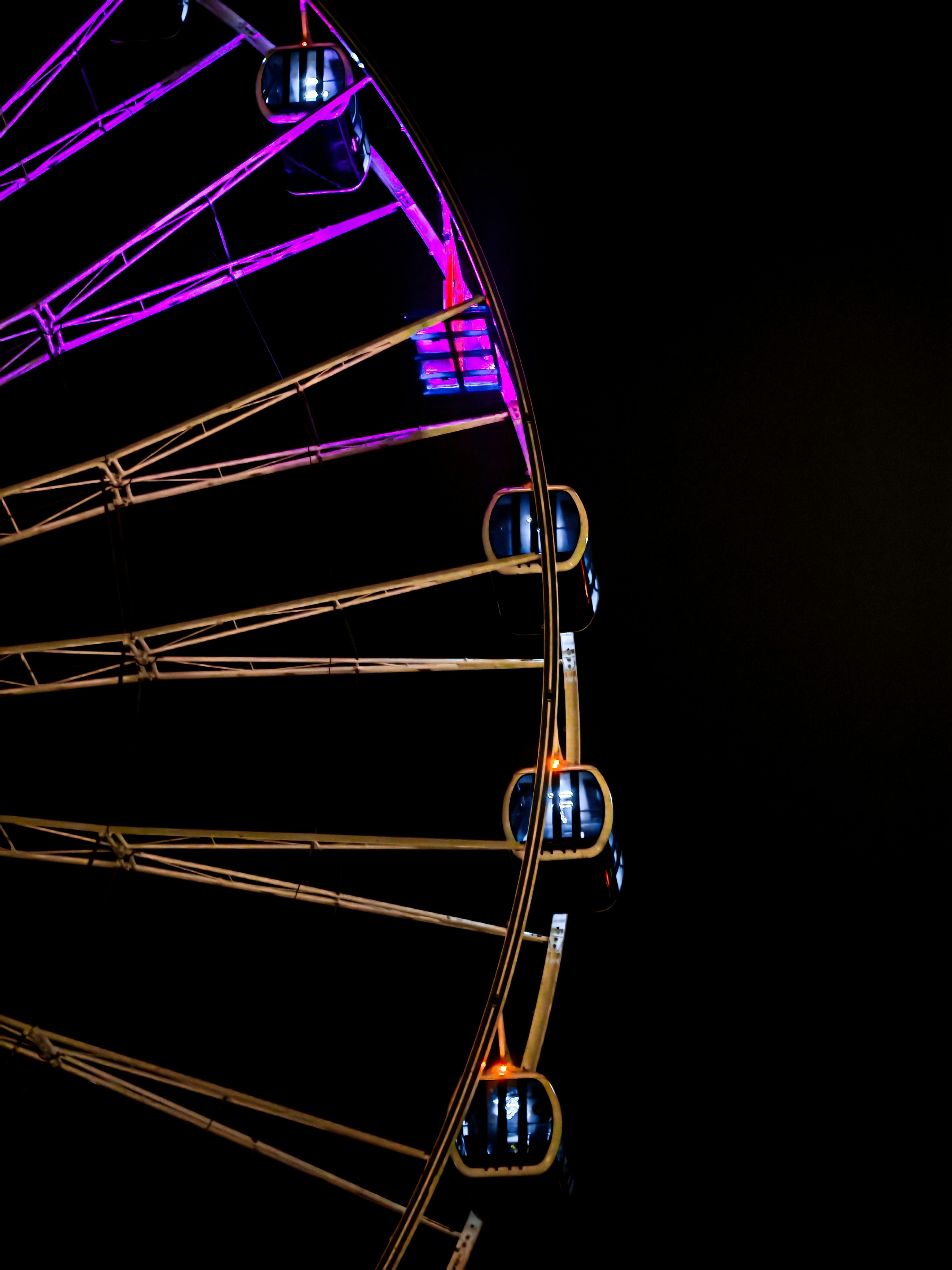Ferris wheel with purple lights at night