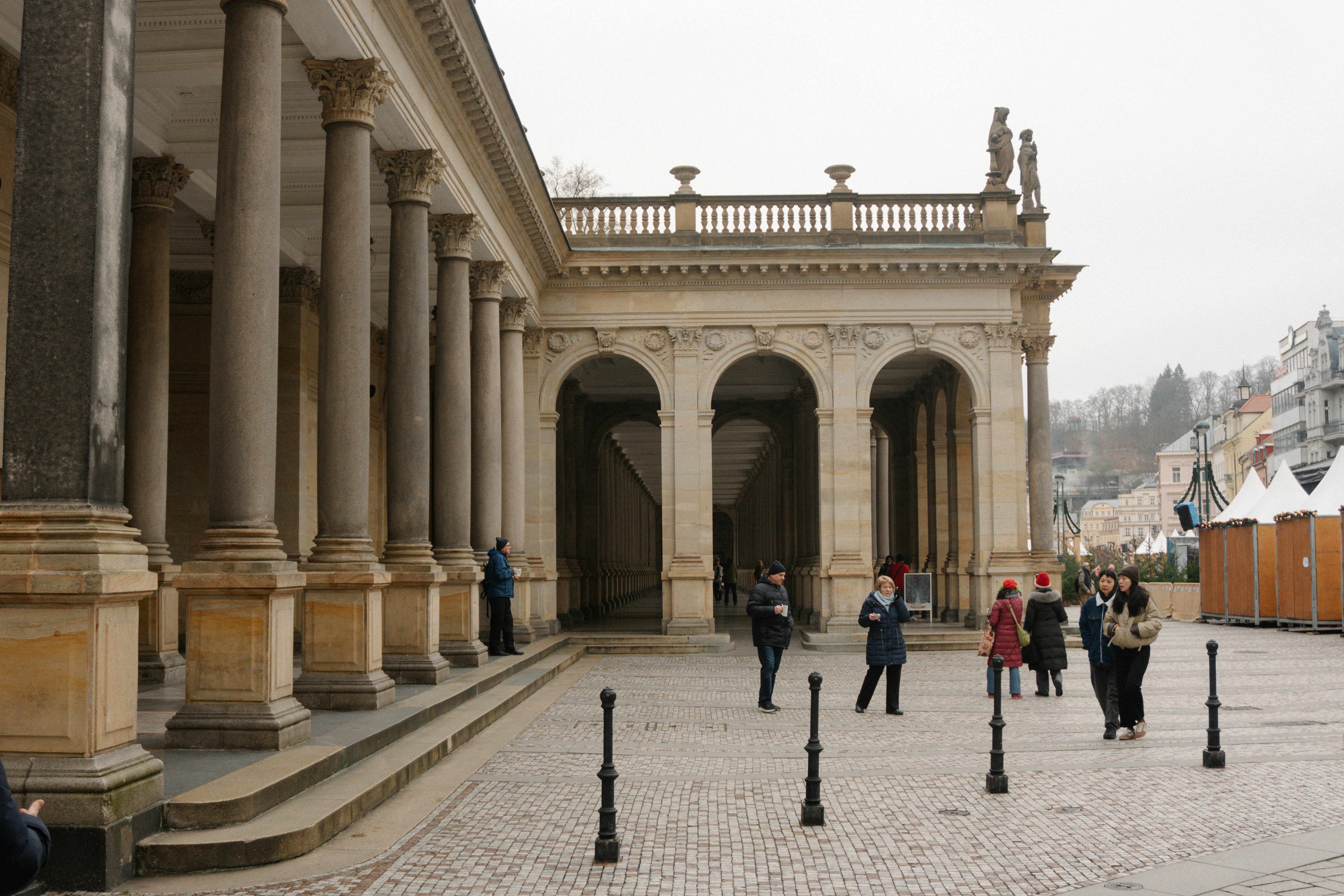 Colonnade Convergence: Visitors at the Palace Courtyard