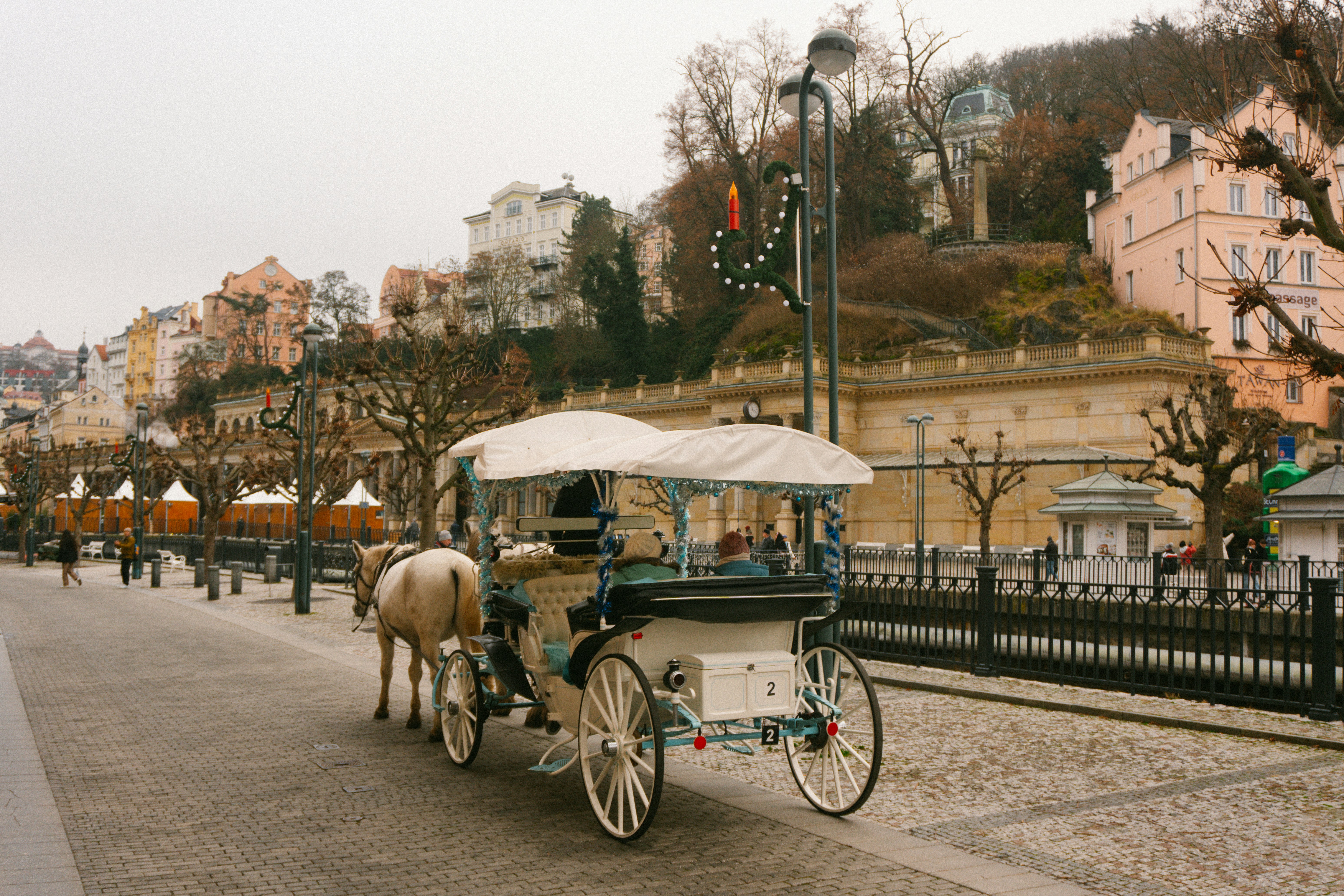 Horse-Drawn Carriage at a Riverside Promenade
