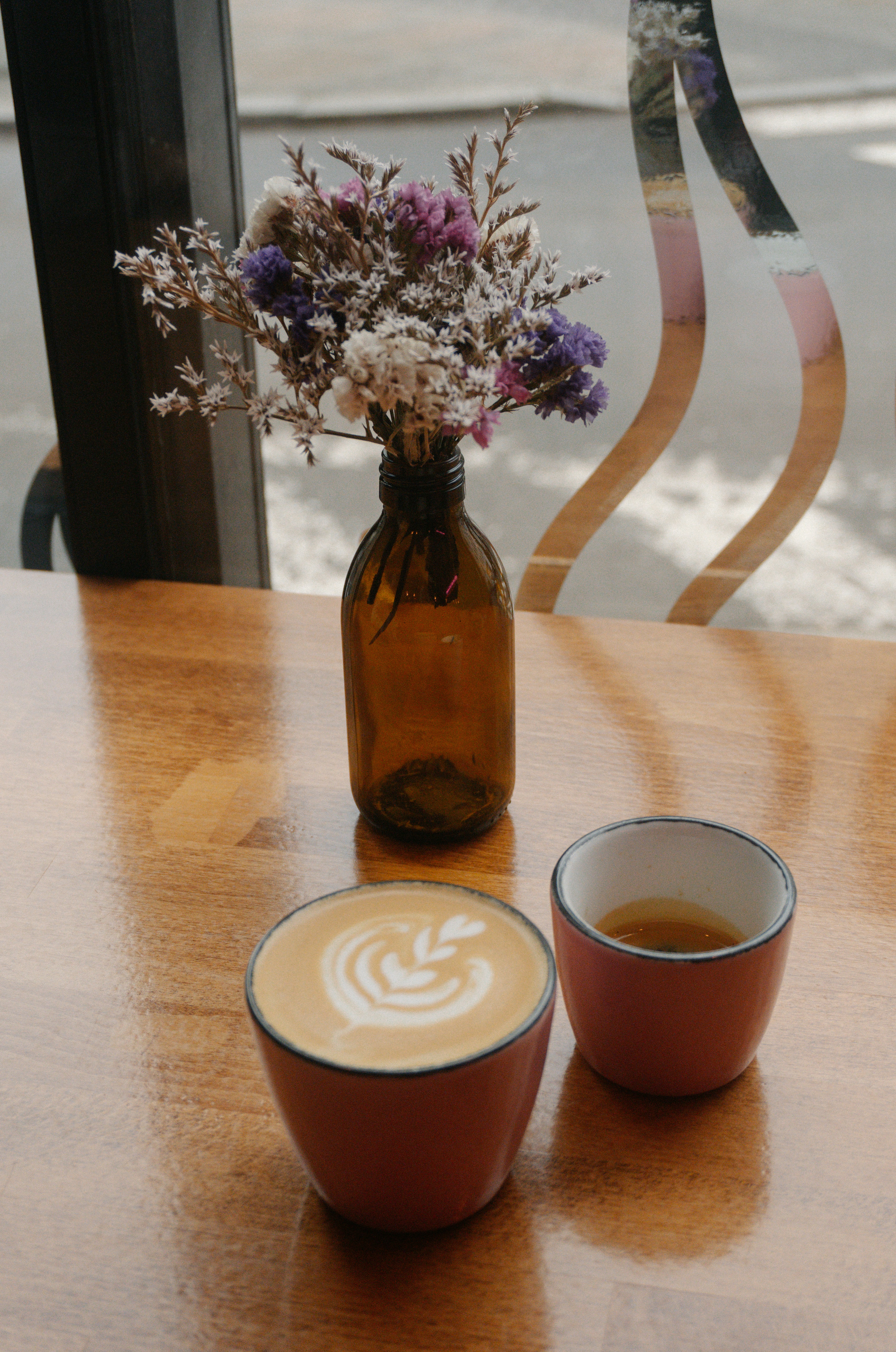 Lavender Bouquet in Amber Bottle Framed by Café Window
