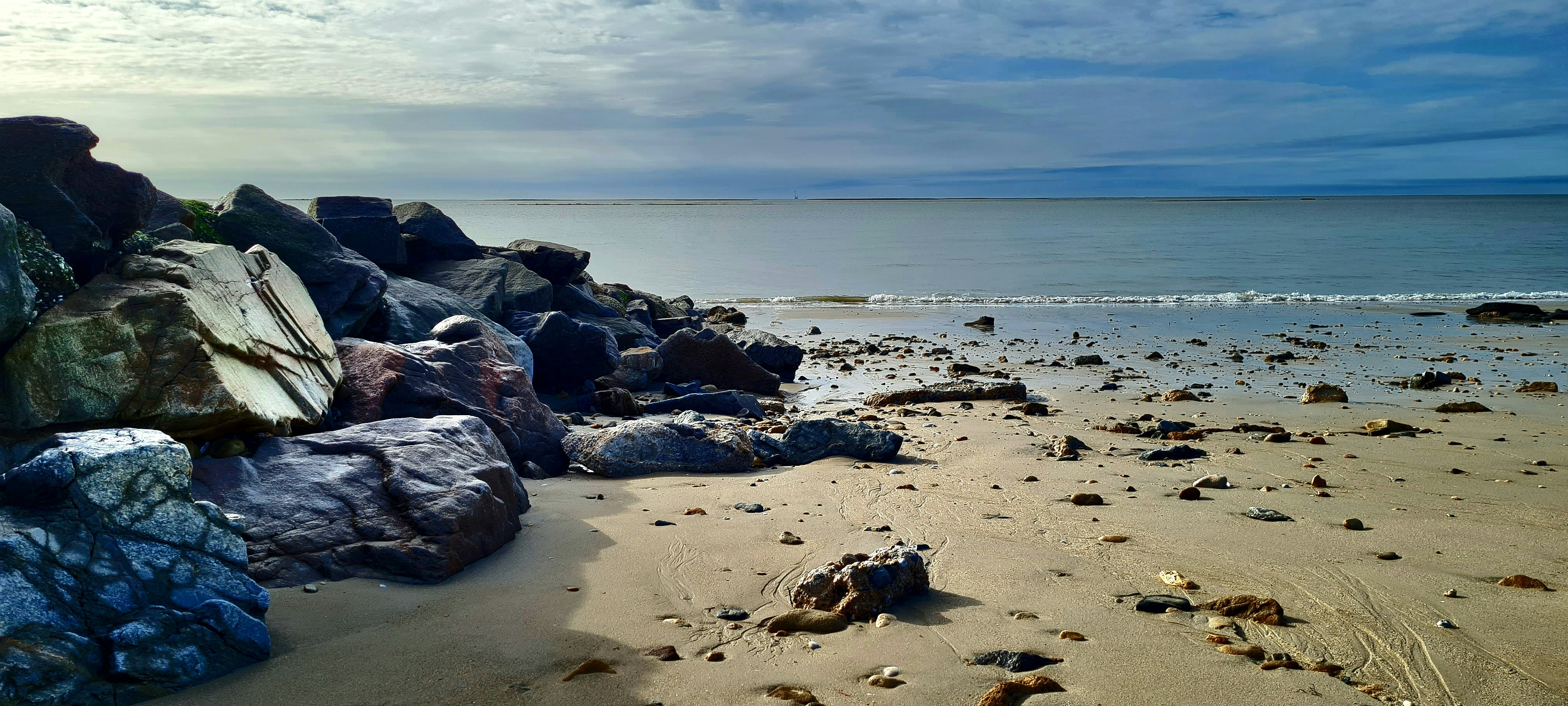 Coastal Drift: Rocky Foreground and Quiet Sea