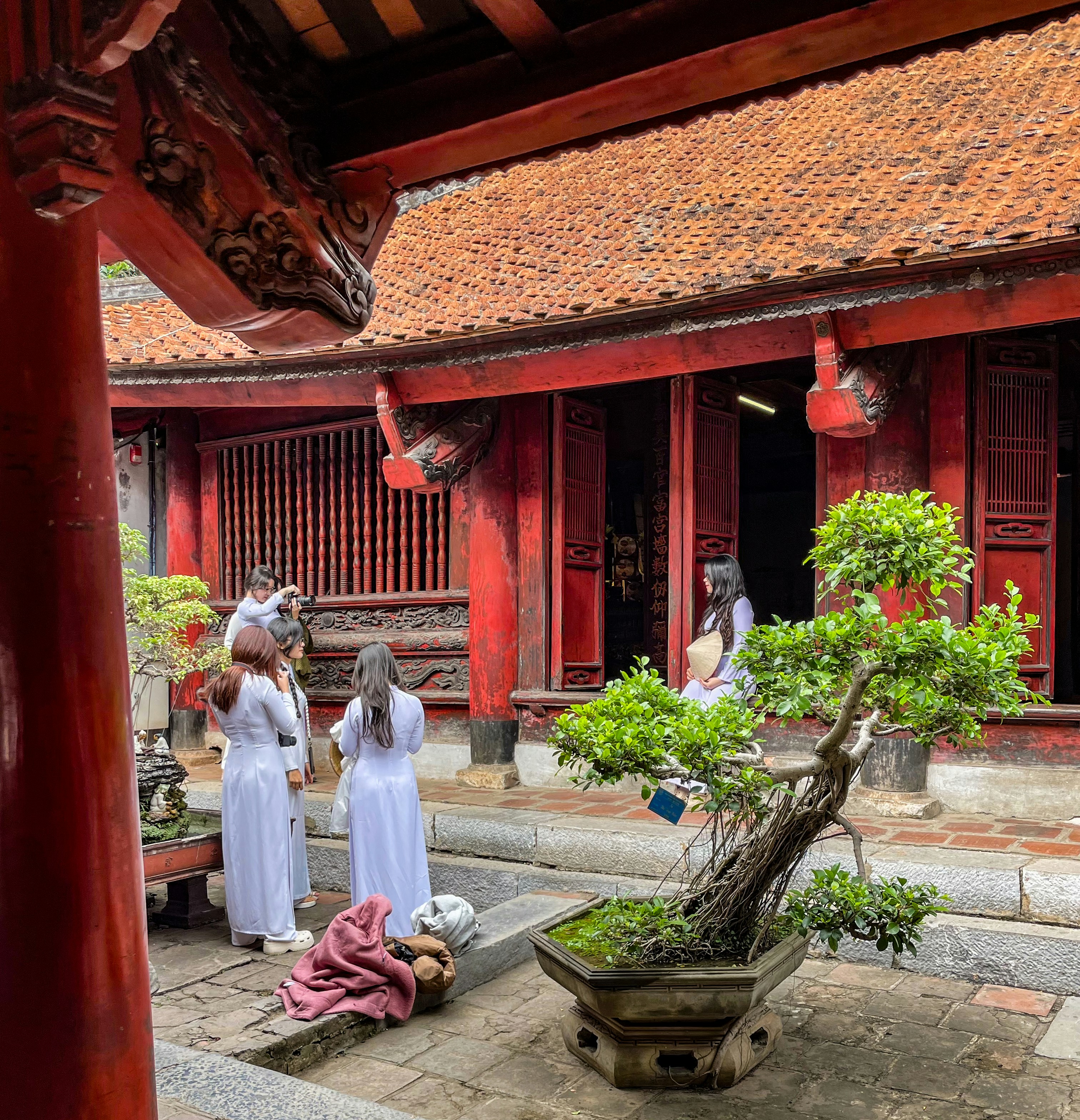 Red Courtyard Reverie: Silent Mendicants in a Temple Garden