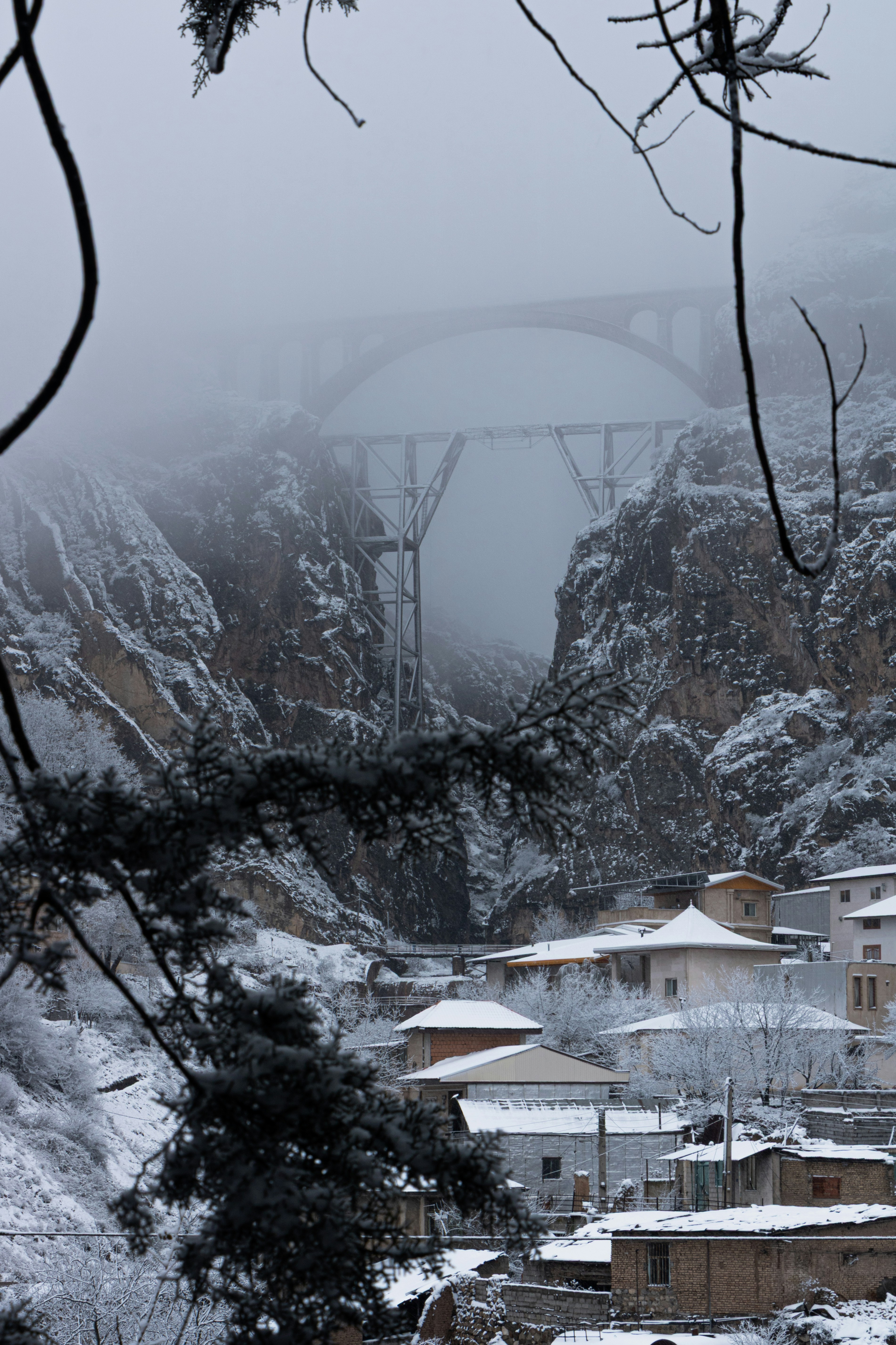 Snowbound Valley: A Veiled Bridge Emerges Through the Mist