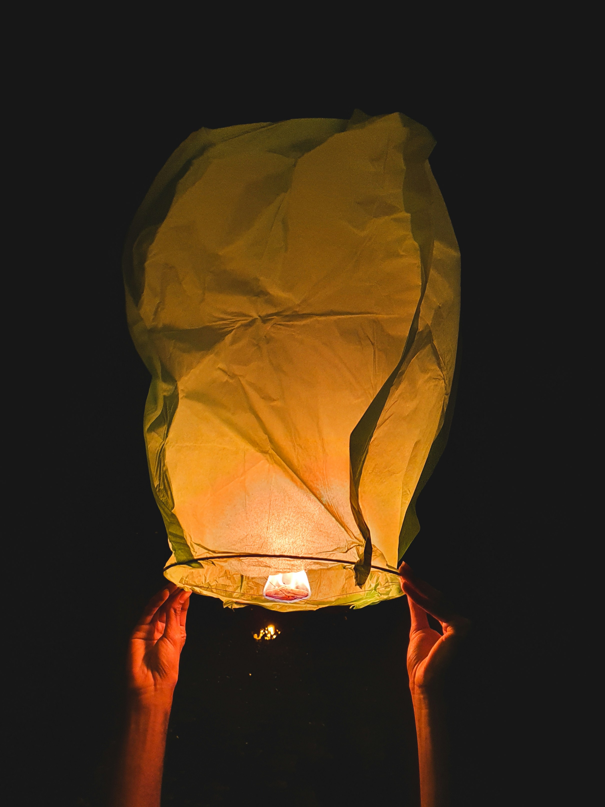 Moonlit Lantern Rising from Dark