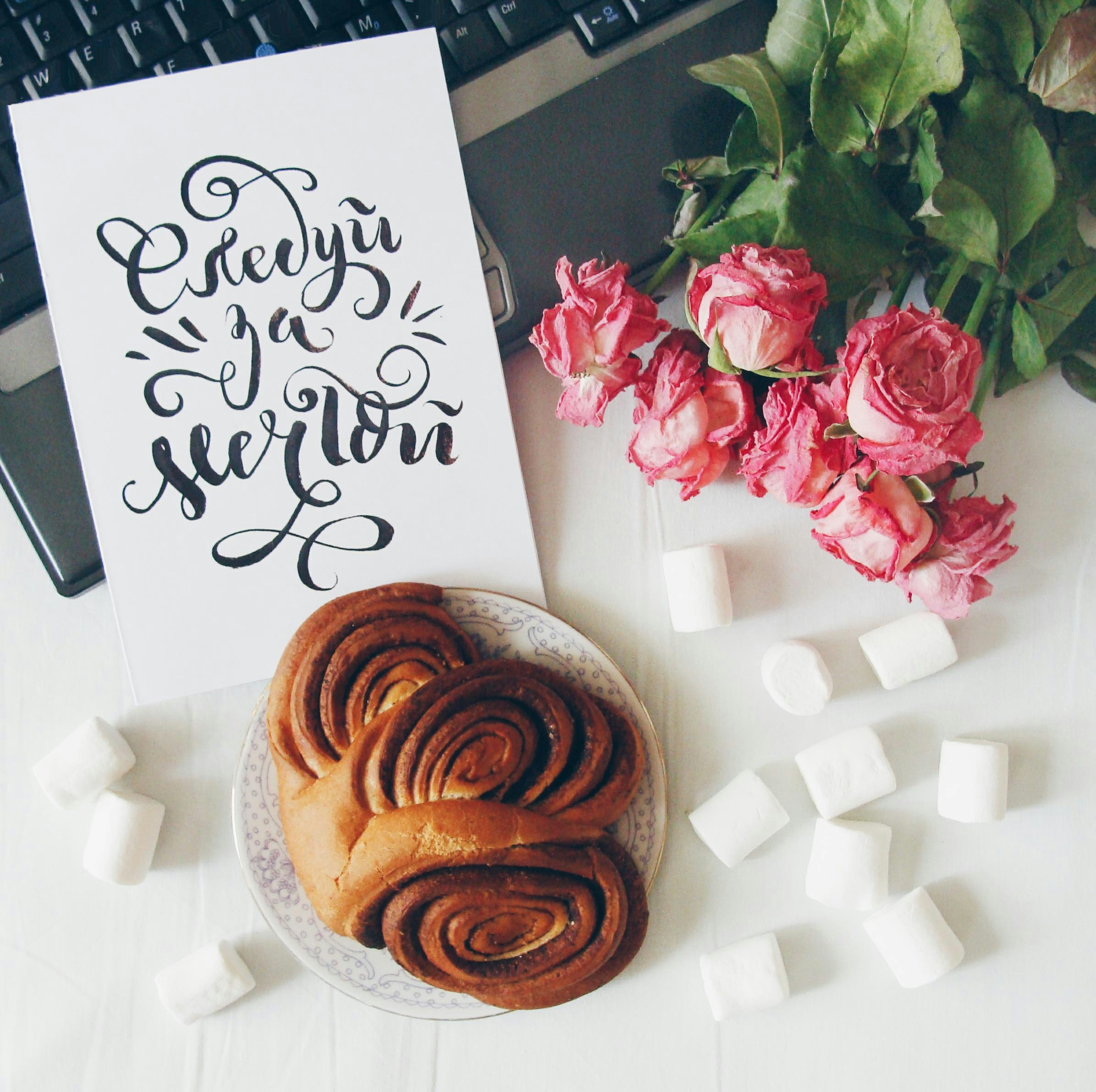 Cinnamon Swirls, Sugar Cubes, and Roses on a Clean Desk