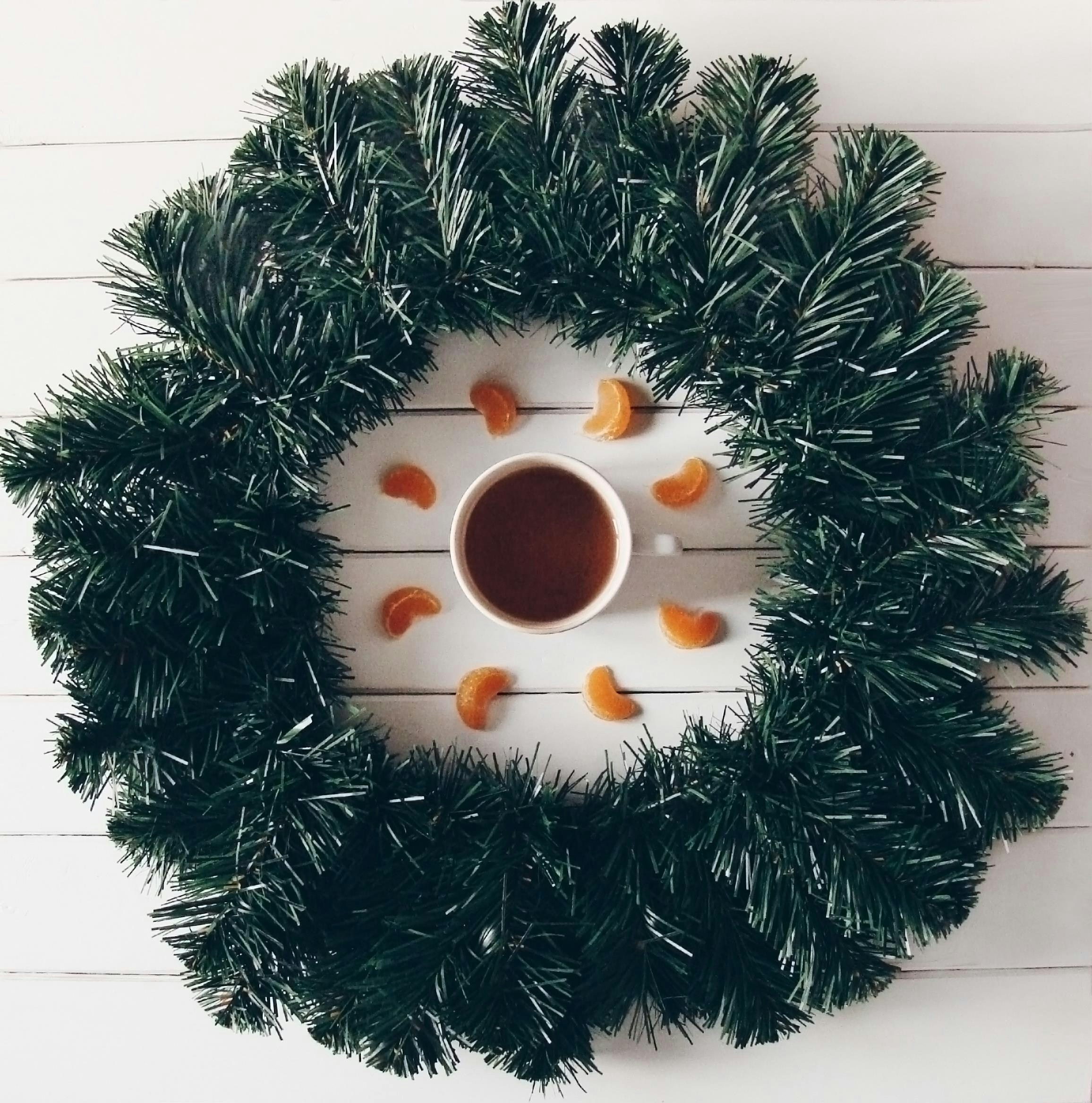 Circular Warmth: A Cup at the Center of a Holiday Wreath