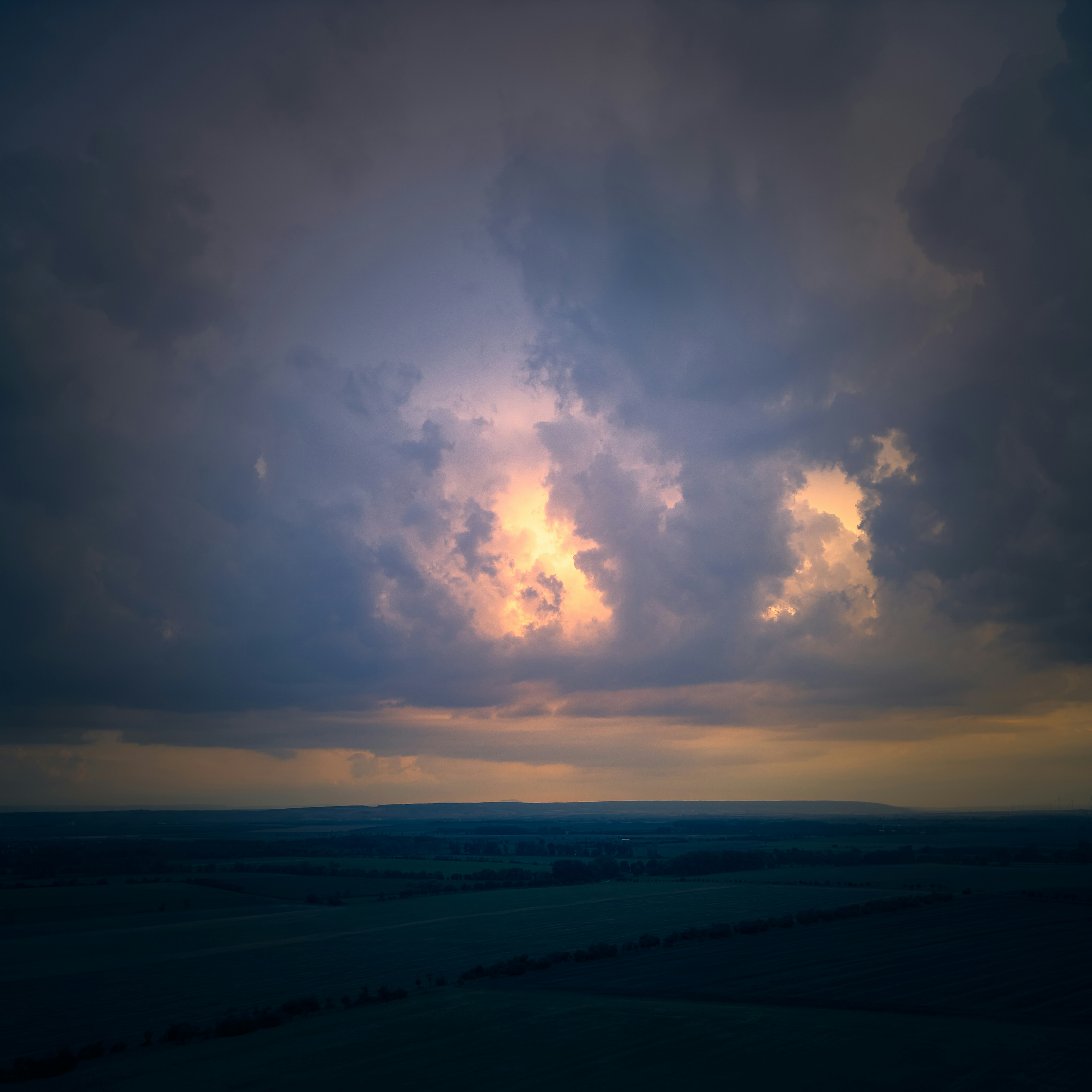 Soft Sunset Over Flat Plains with Dramatic Clouds