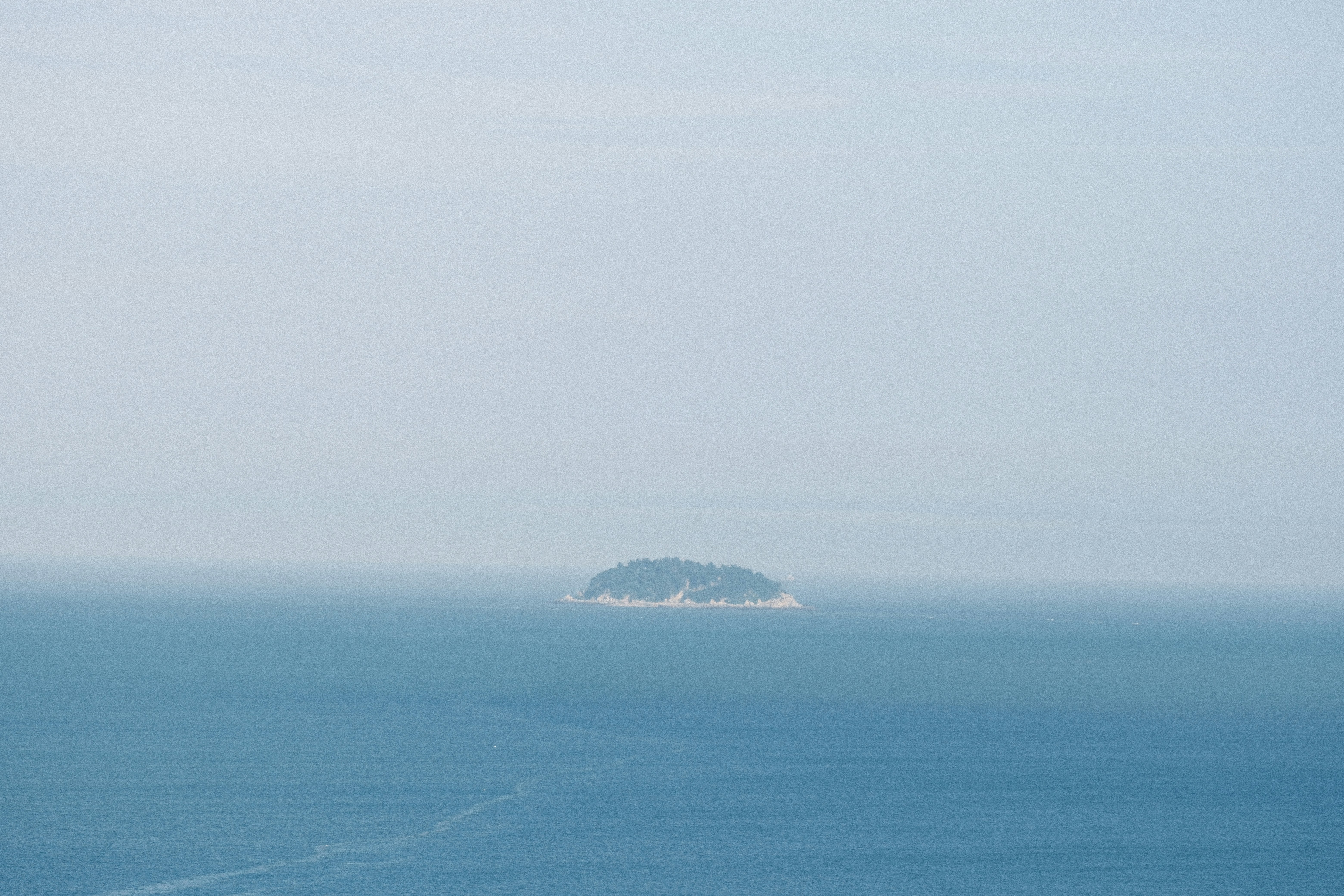 Isolated Island Quietly Anchored in the Blue Expanse