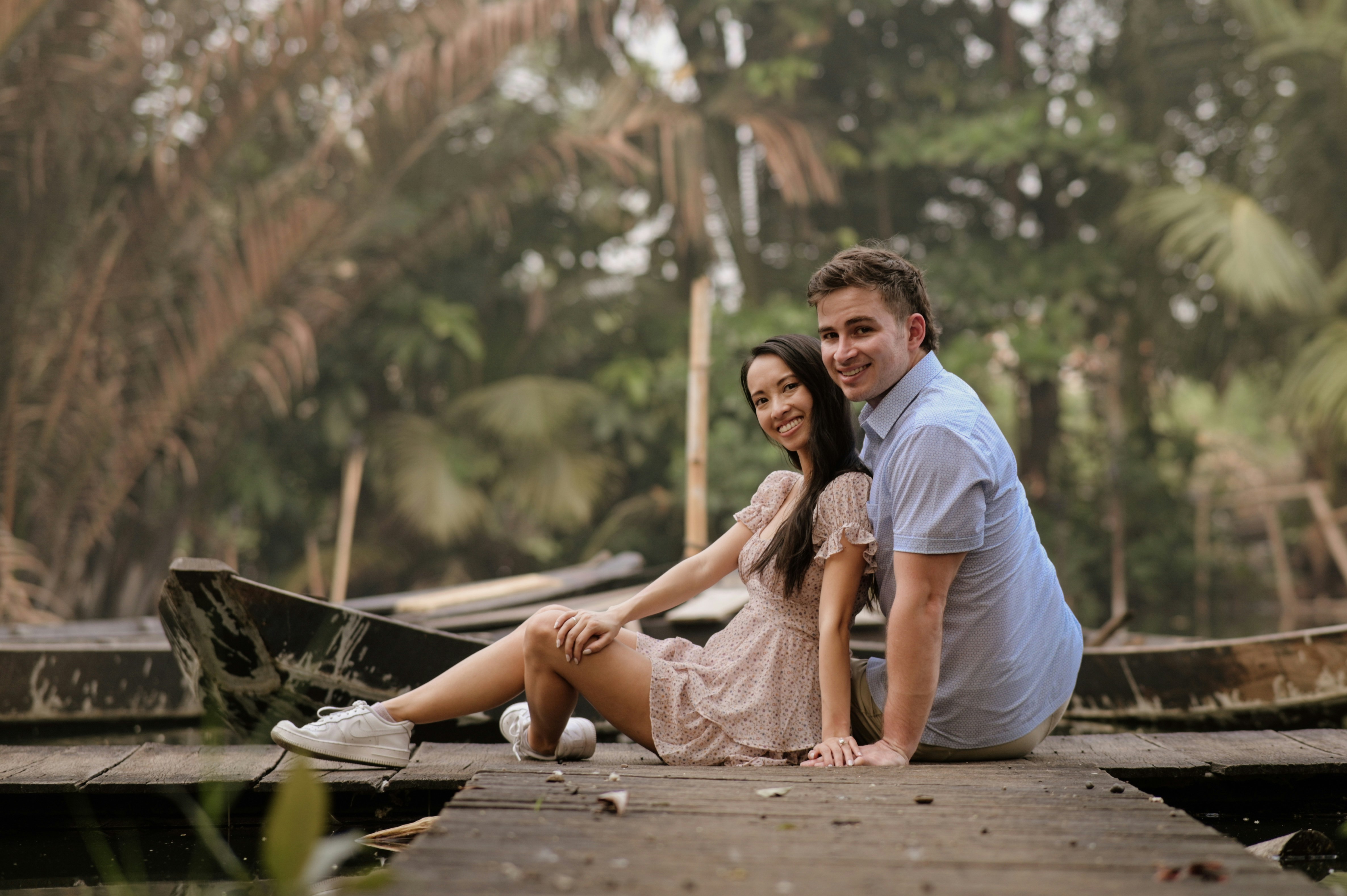 Couple in soft embrace on a weathered dock at dusk
