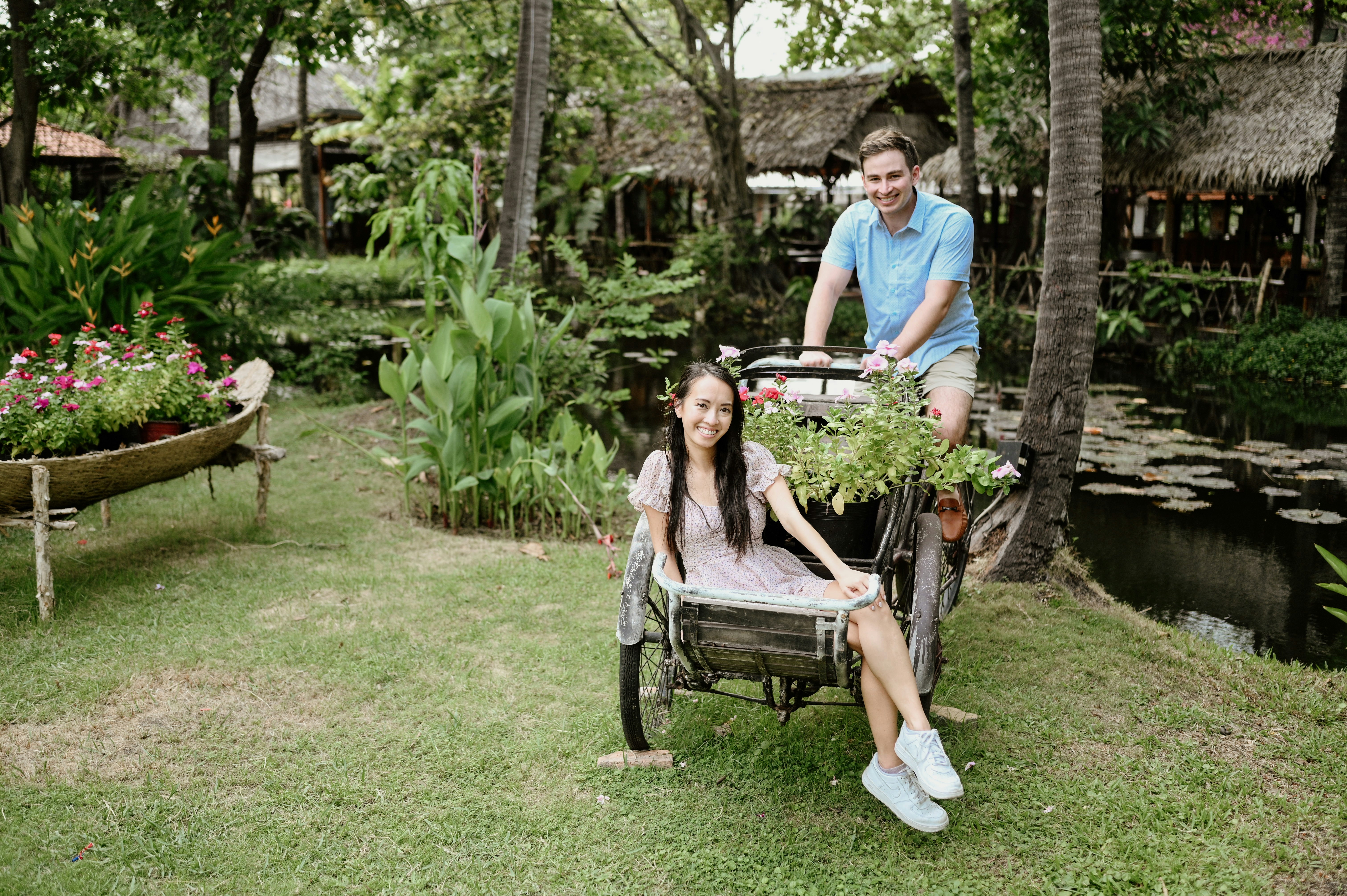 Joyride in the Garden: A Couple Pushes a Wheelbarrow of Laughter