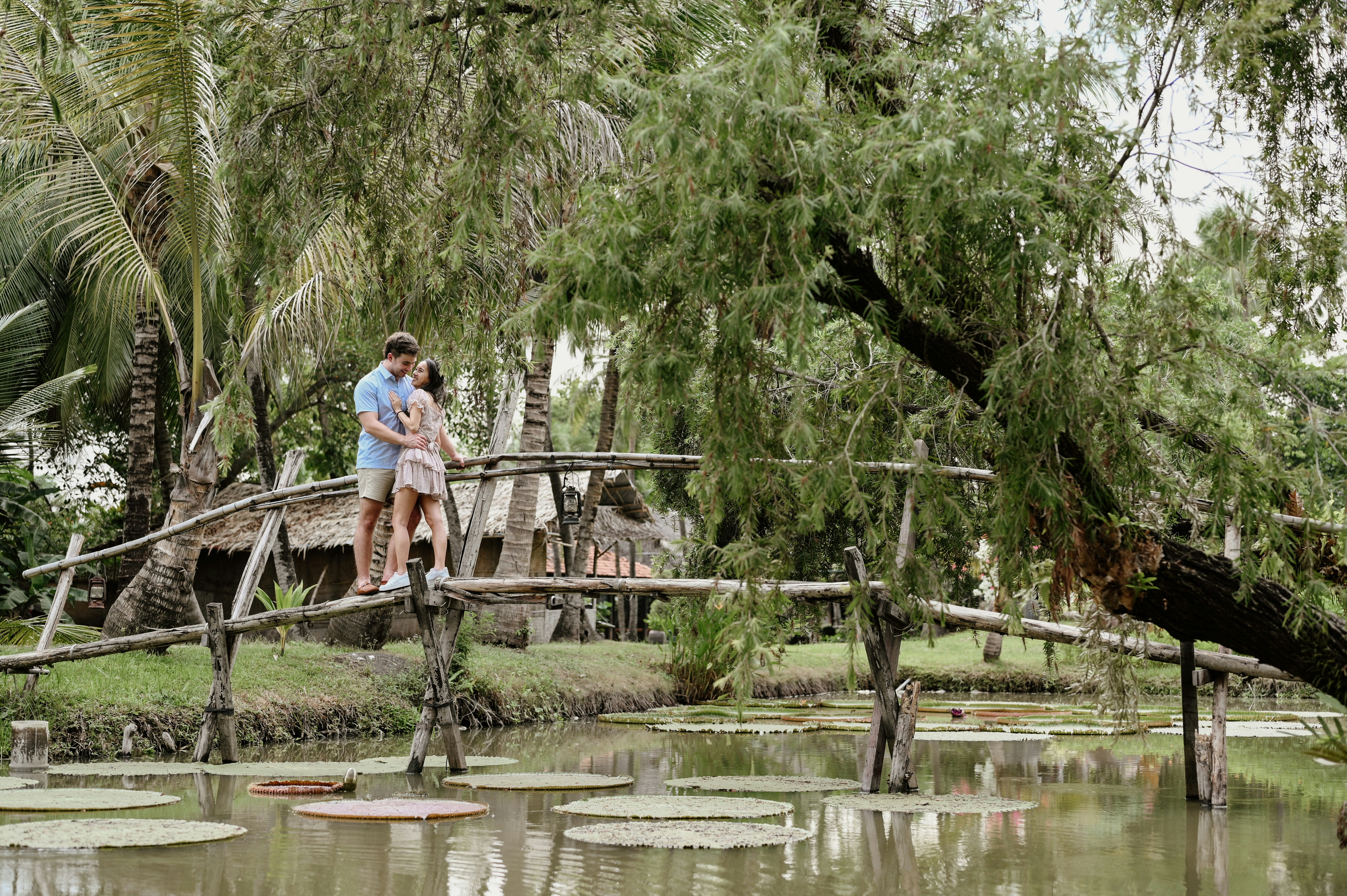 Bridge of Quiet Moments: A Couple Amid Water Lilies