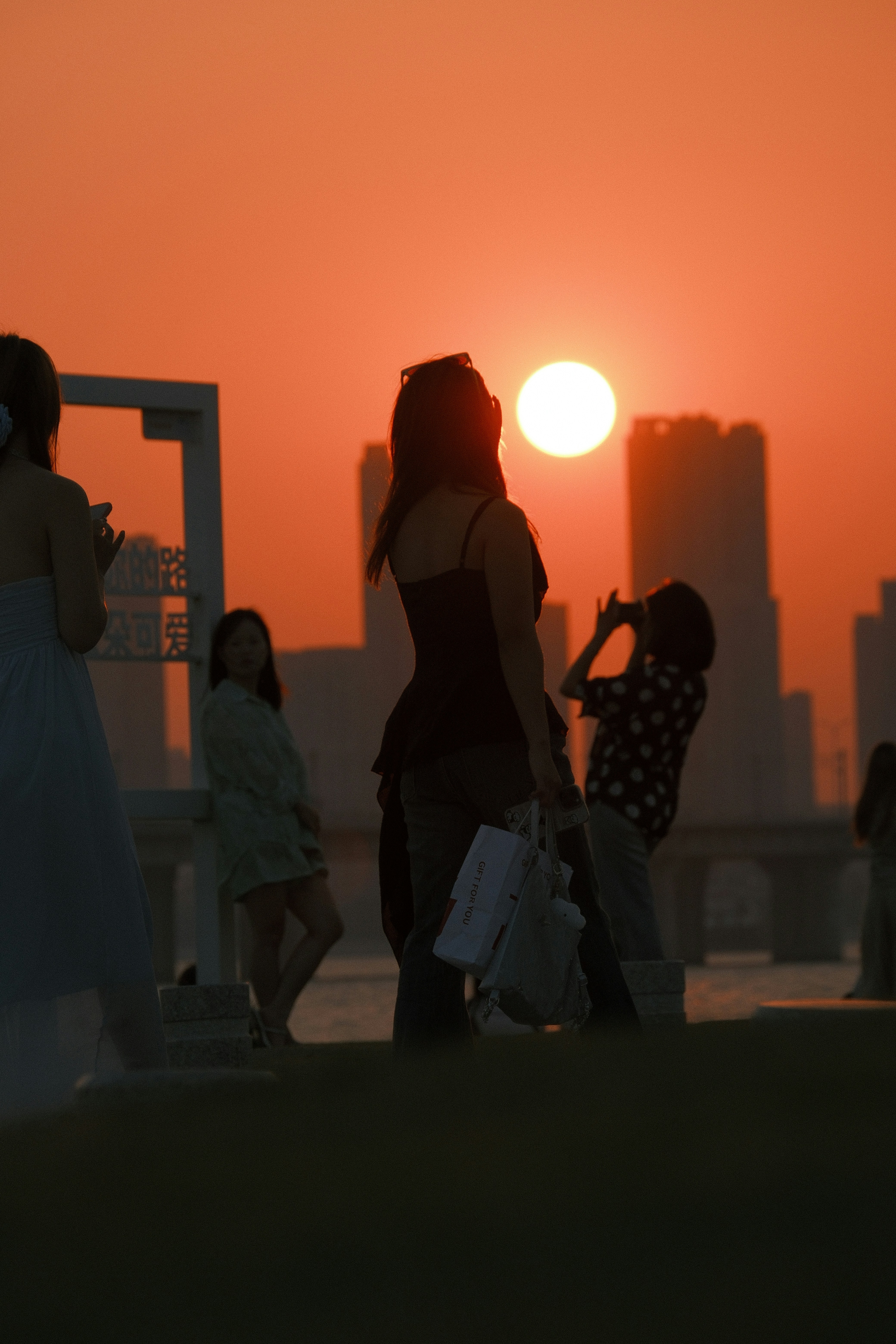 Sunset in Focus: A silhouetted moment among city off-frames