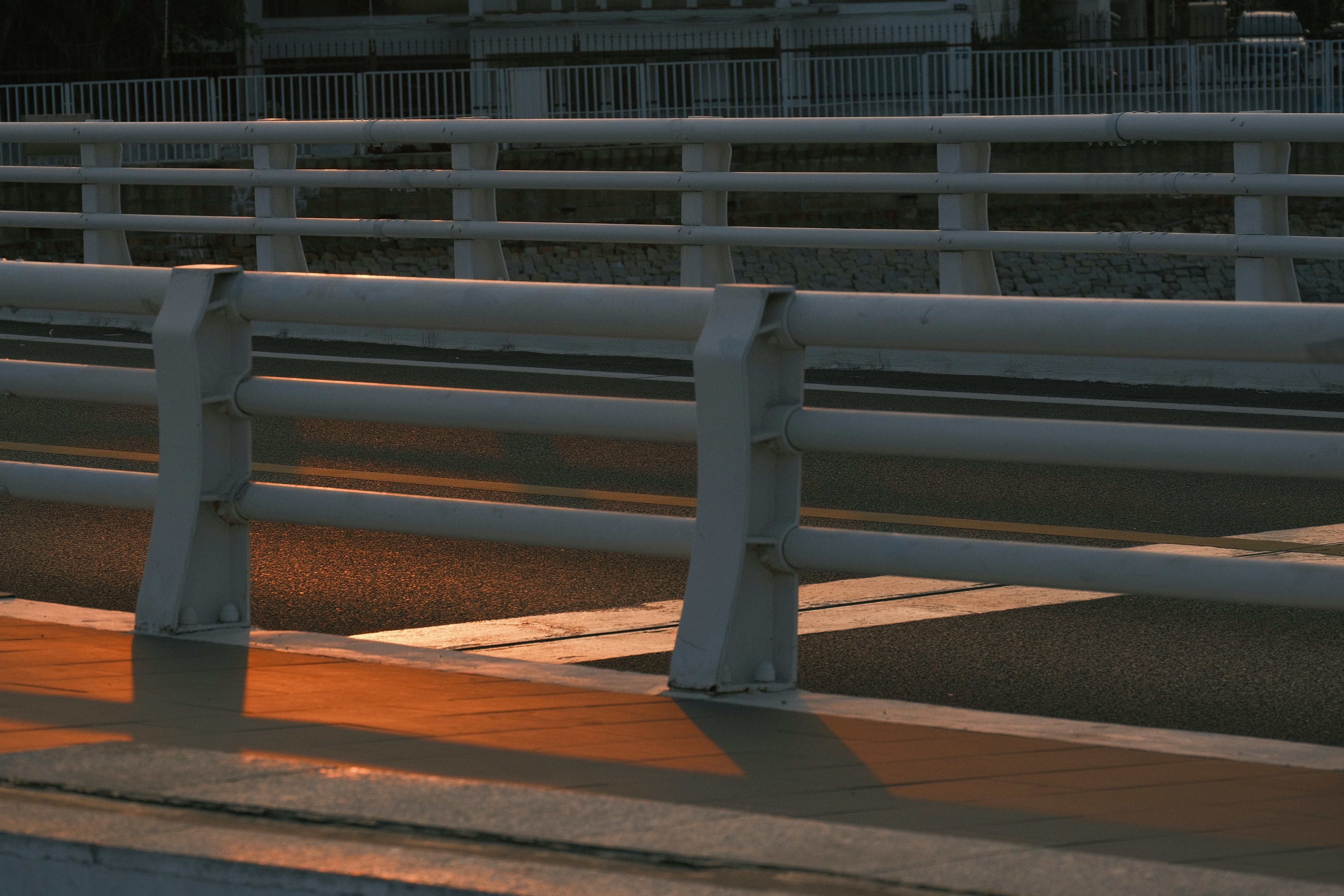 Sunlit Railing Across a Quiet Street