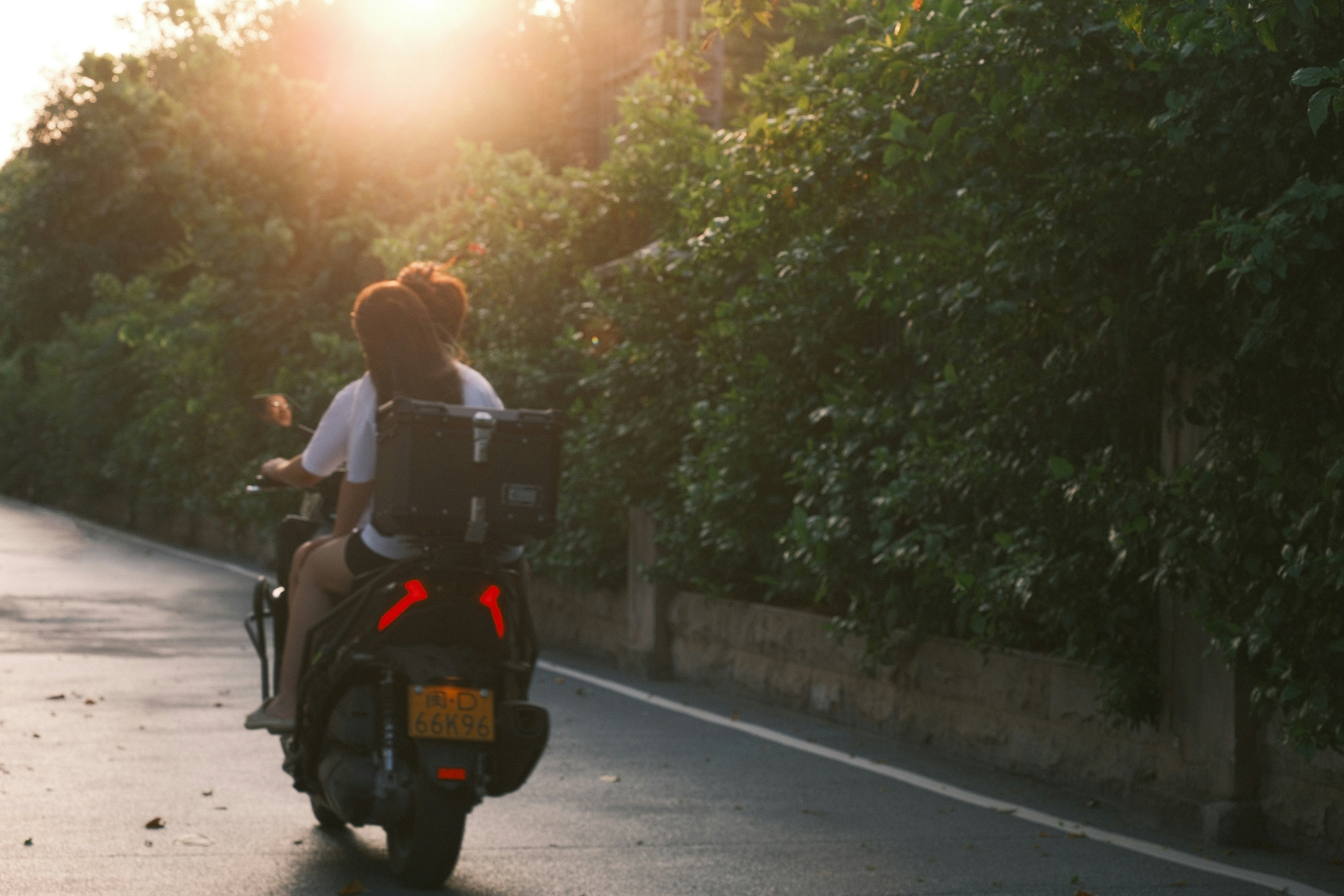 Twilight Ride: Evening commuters in a sunlit lane
