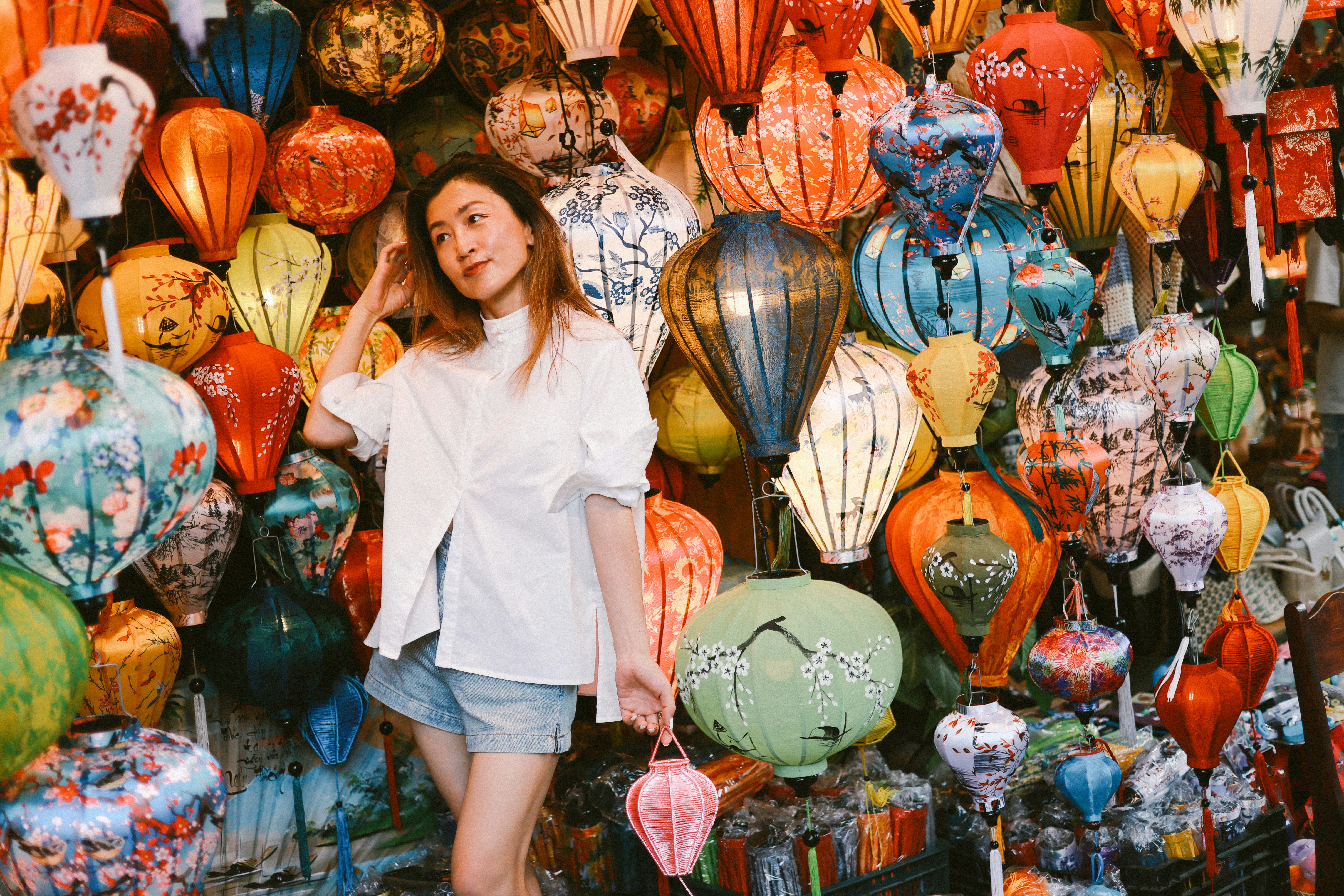 Colorful Lantern Portrait: A woman among lanterns in vivid alleyway